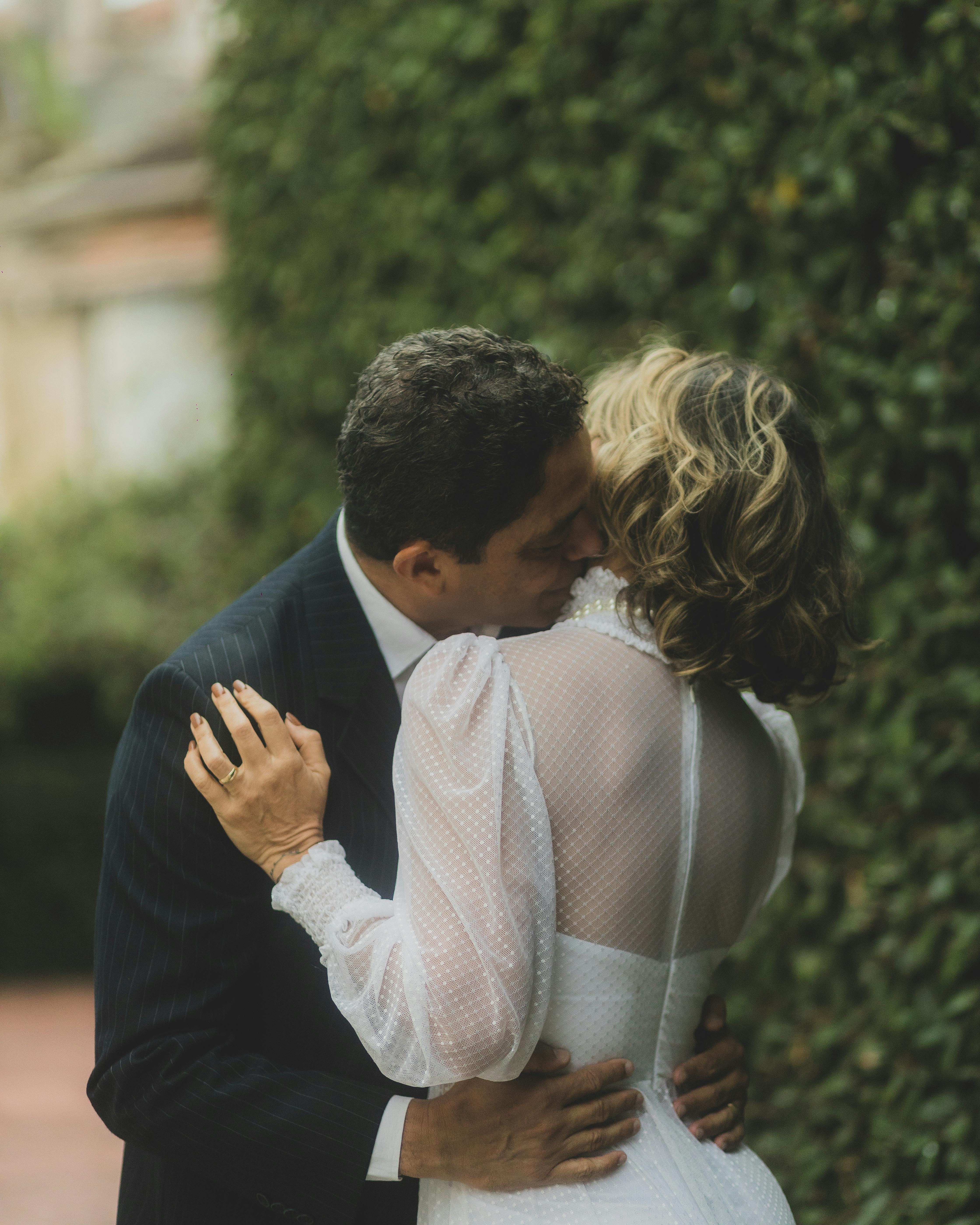 A Bride and a Bridegroom Hugging Each Other · Free Stock Photo
