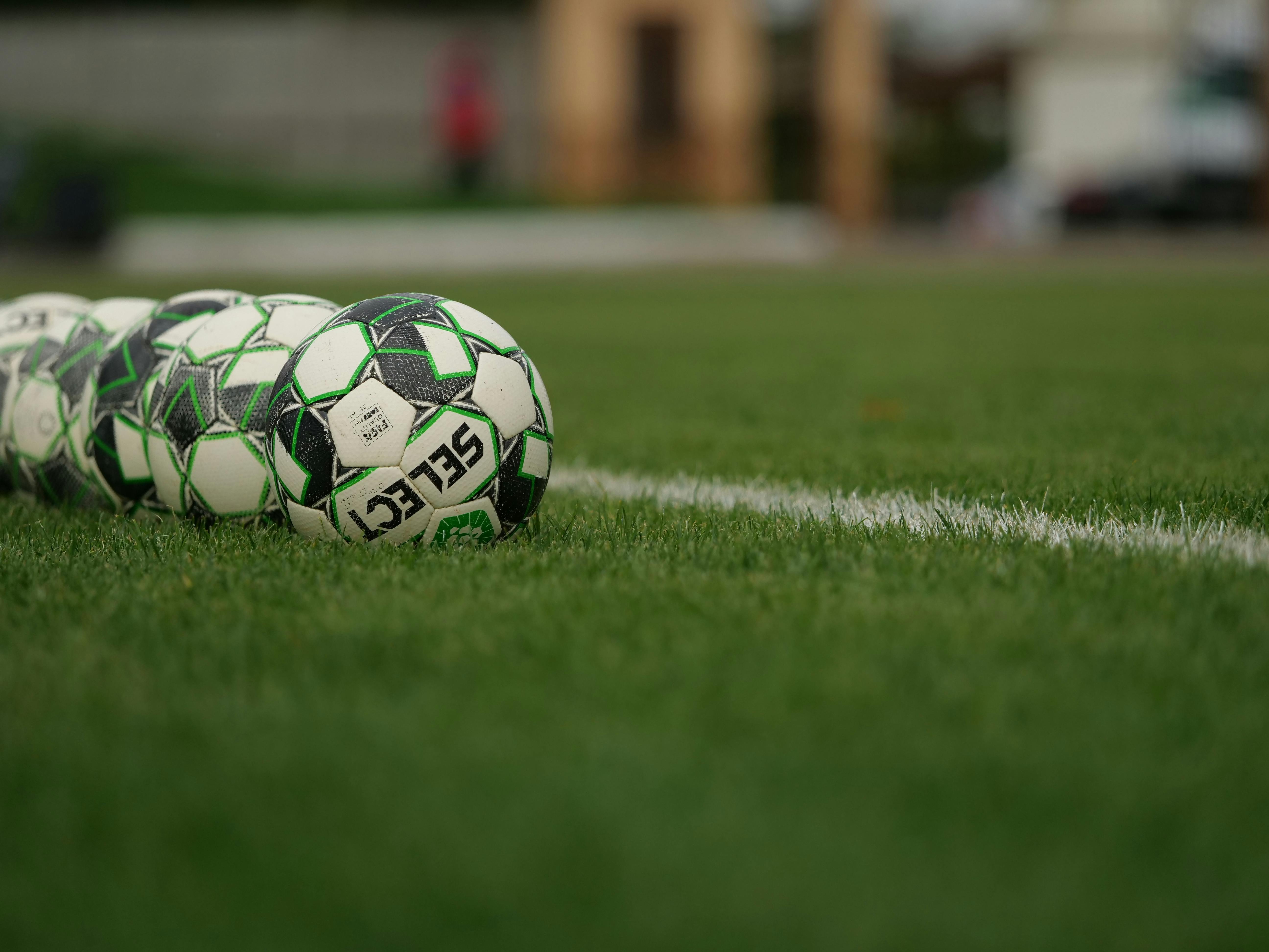 Soccerball on Wide Green Grass Field · Free Stock Photo