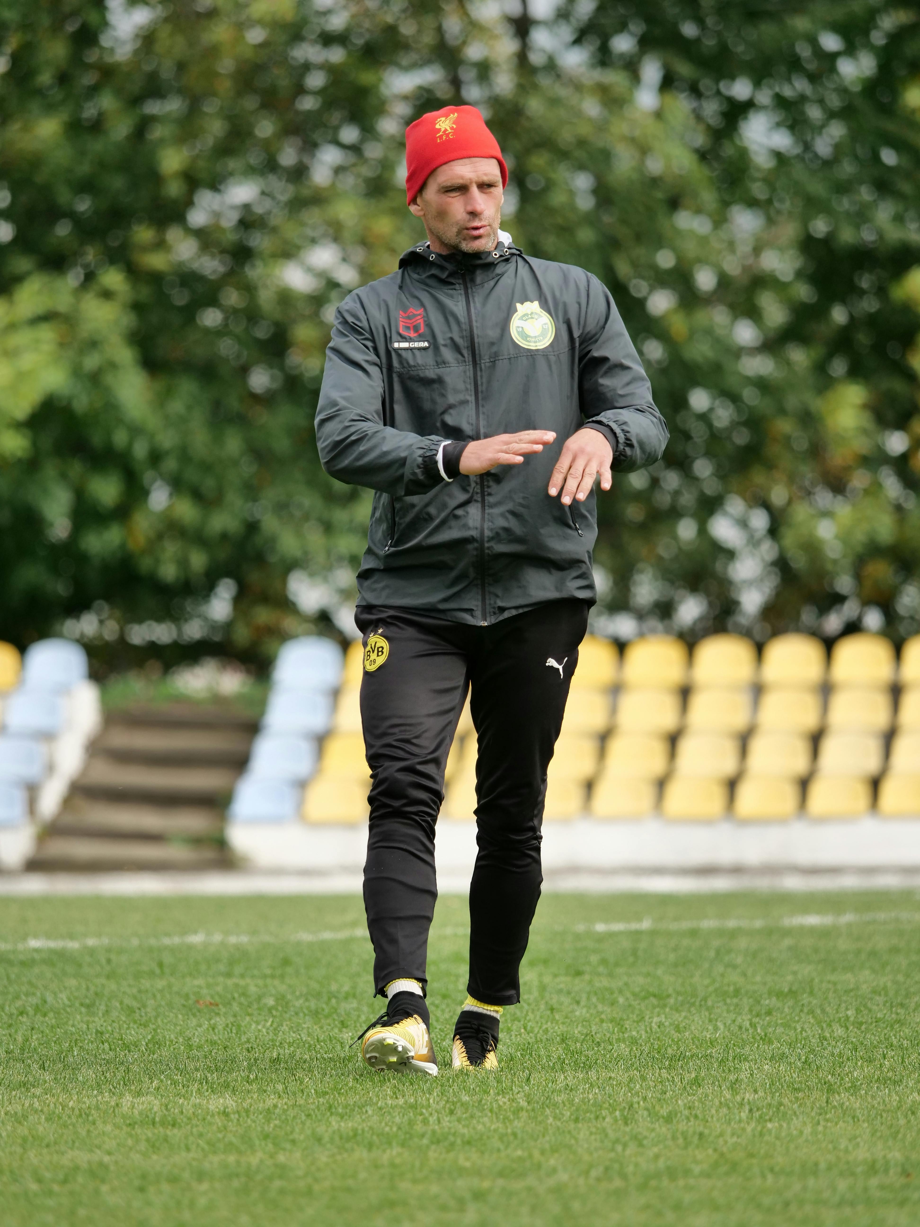 Football Coach on Pitch · Free Stock Photo