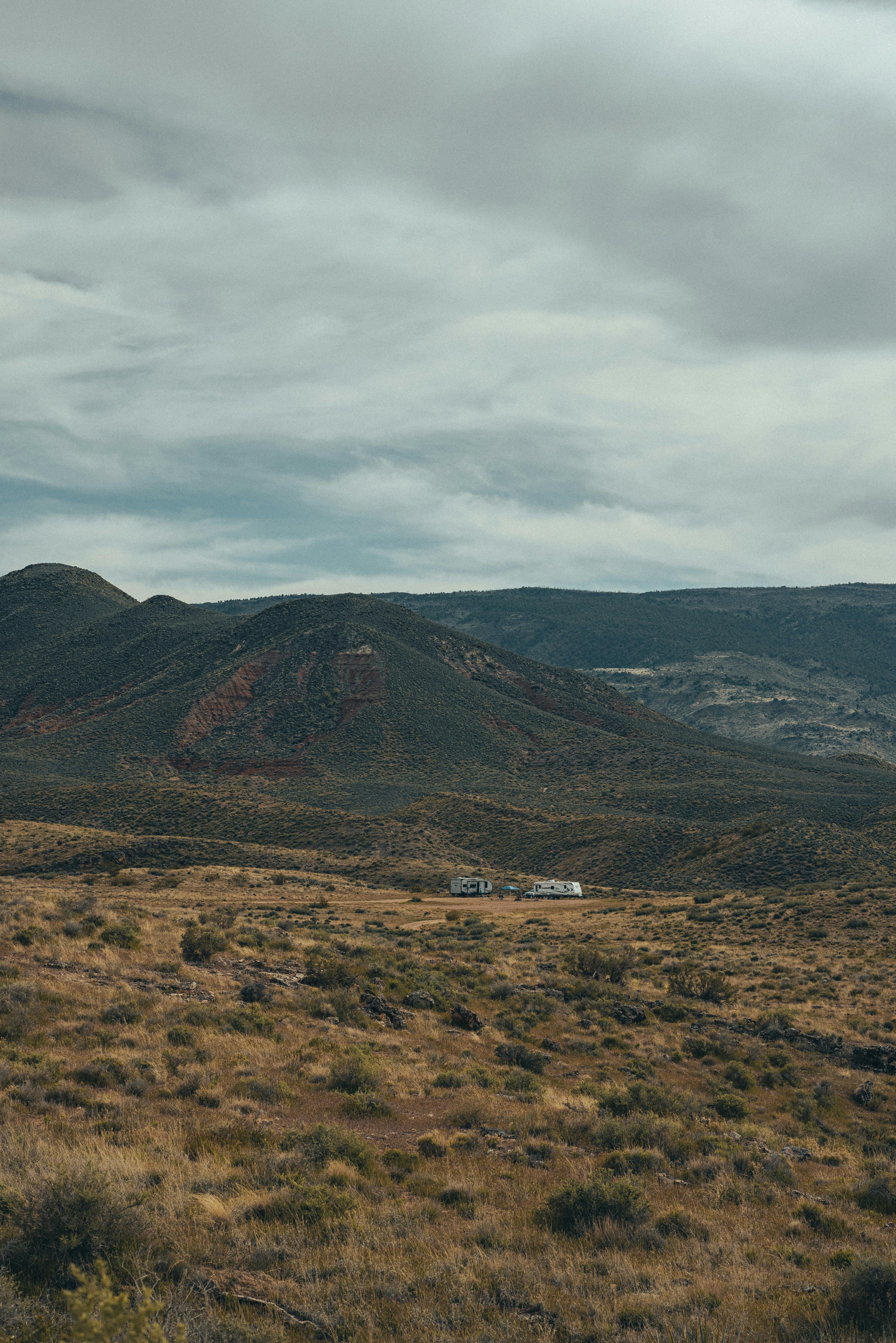 Campers Standing in the middle of Valley · Free Stock Photo