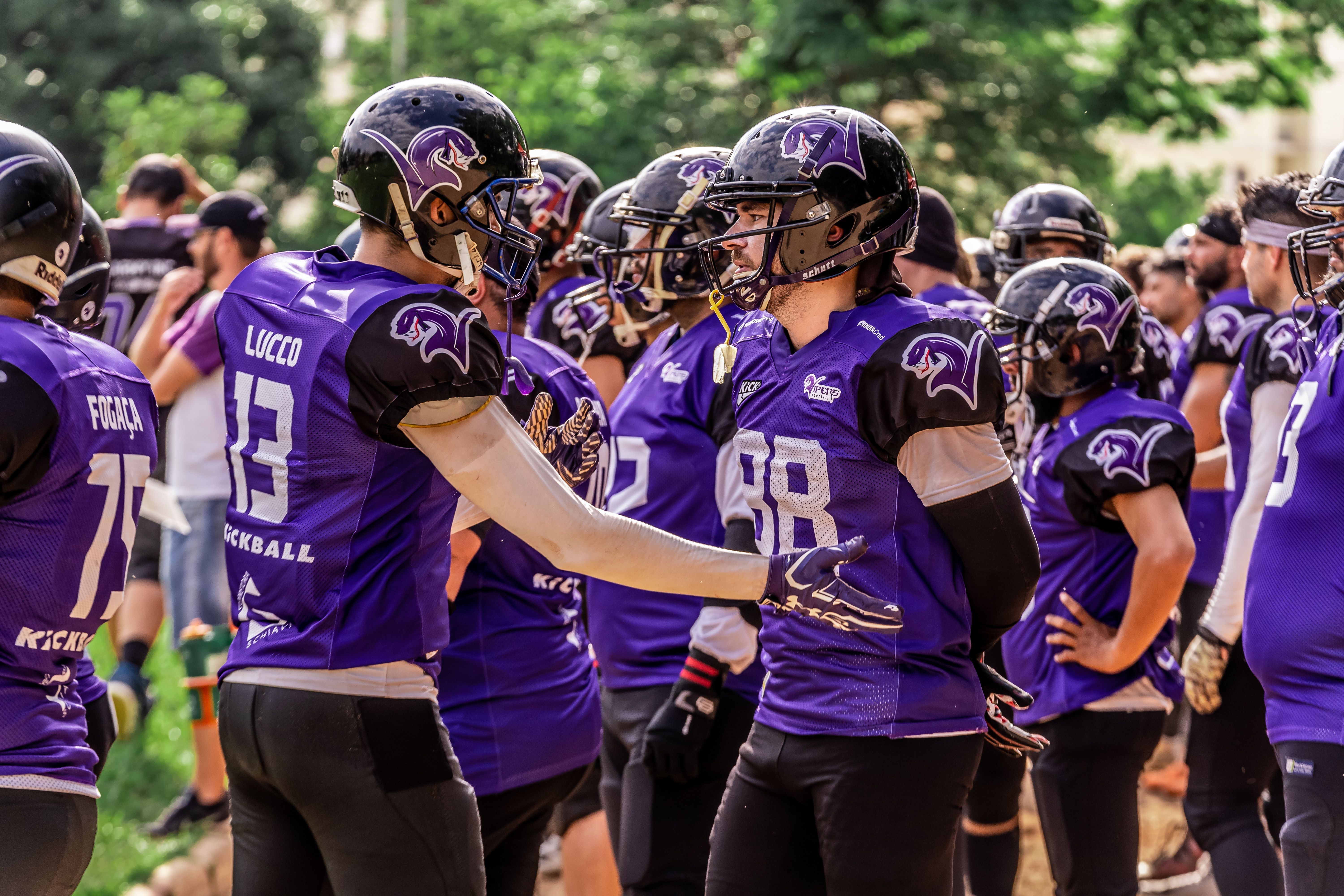 American Football Players in Purple Jerseys · Free Stock Photo