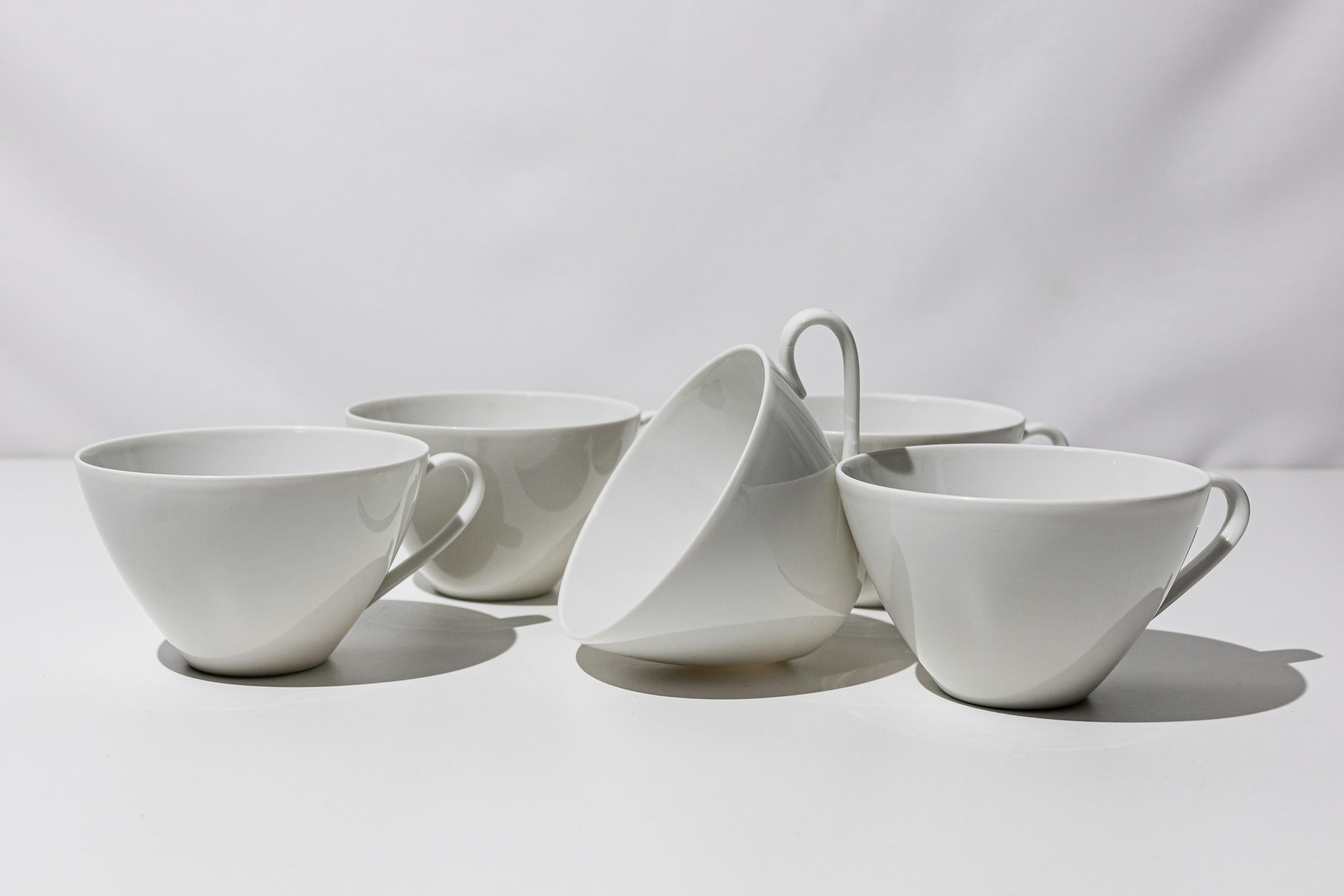 A set of six white cups with handles · Free Stock Photo