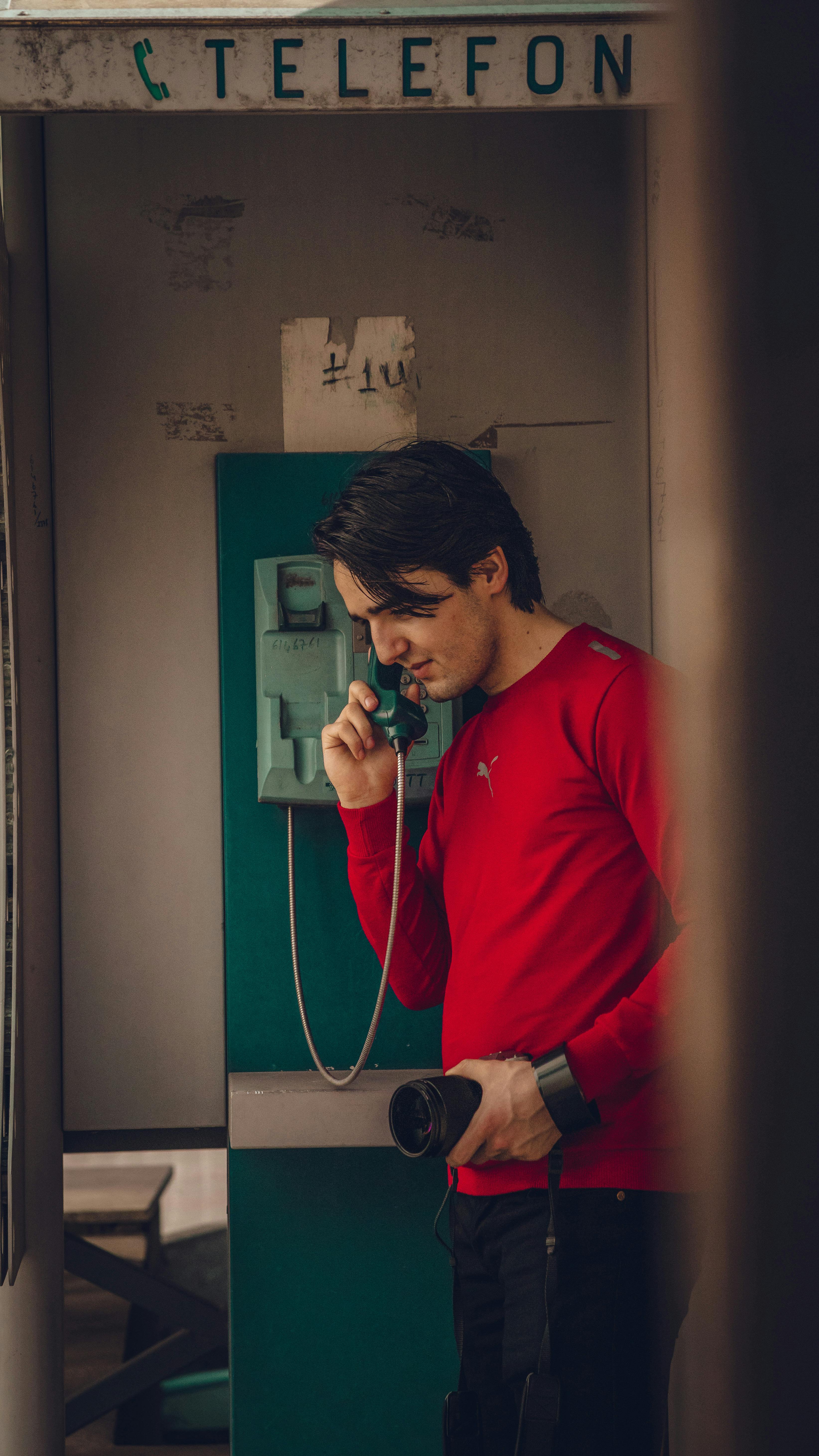 Man Talking in Telephone Box · Free Stock Photo