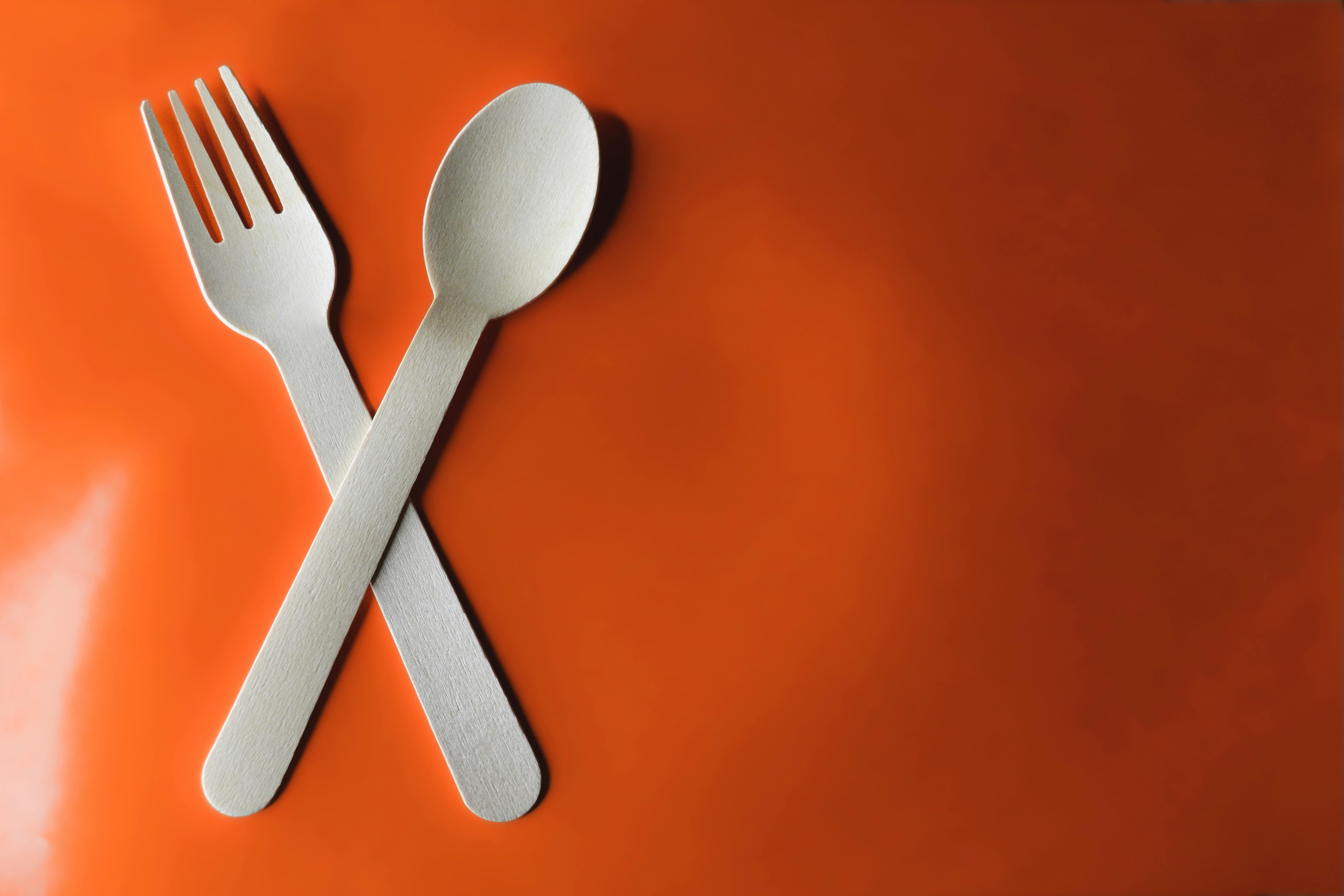 Set of cutlery from various material on marble surface · Free Stock Photo