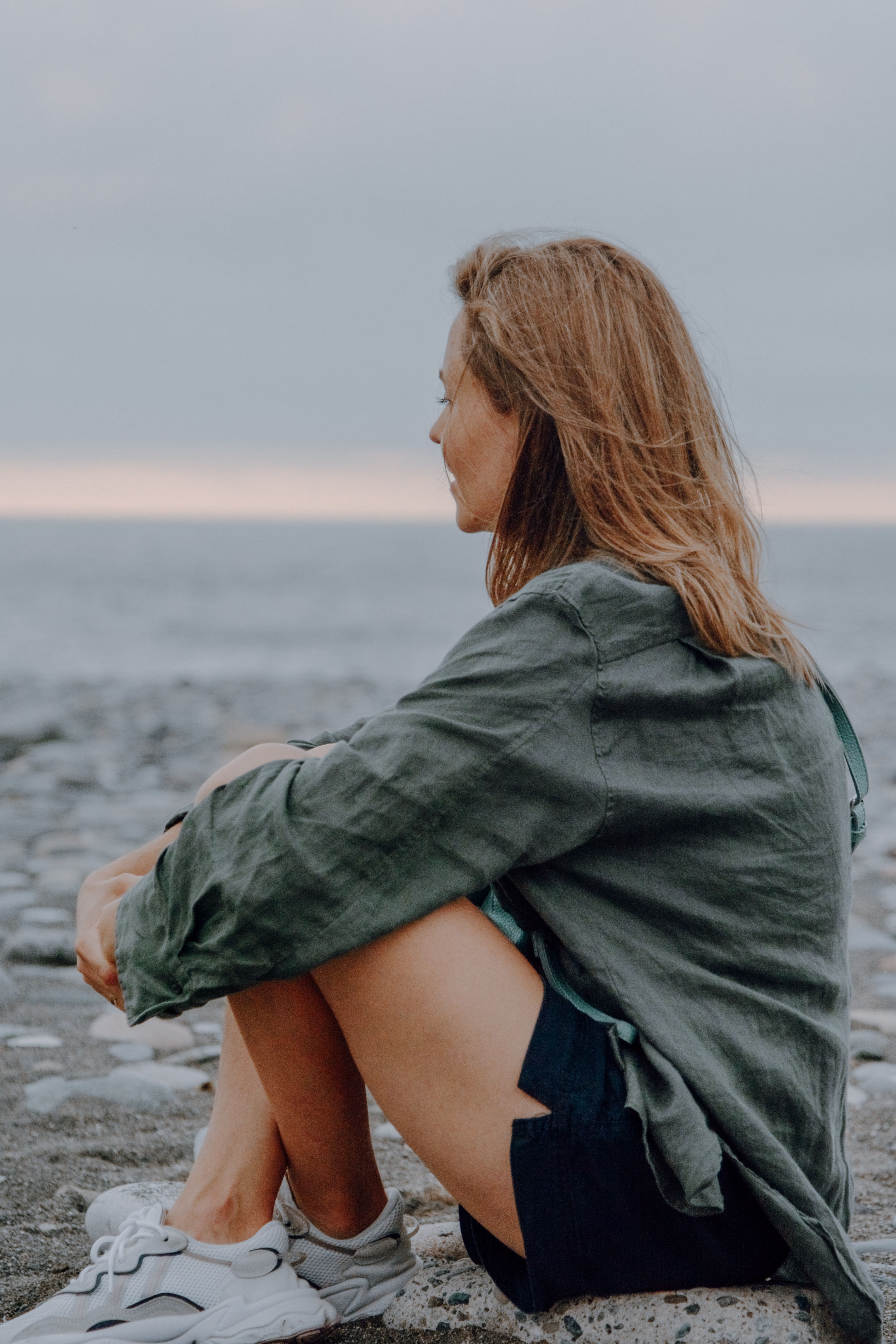 Woman in Jacket Sitting and Posing · Free Stock Photo