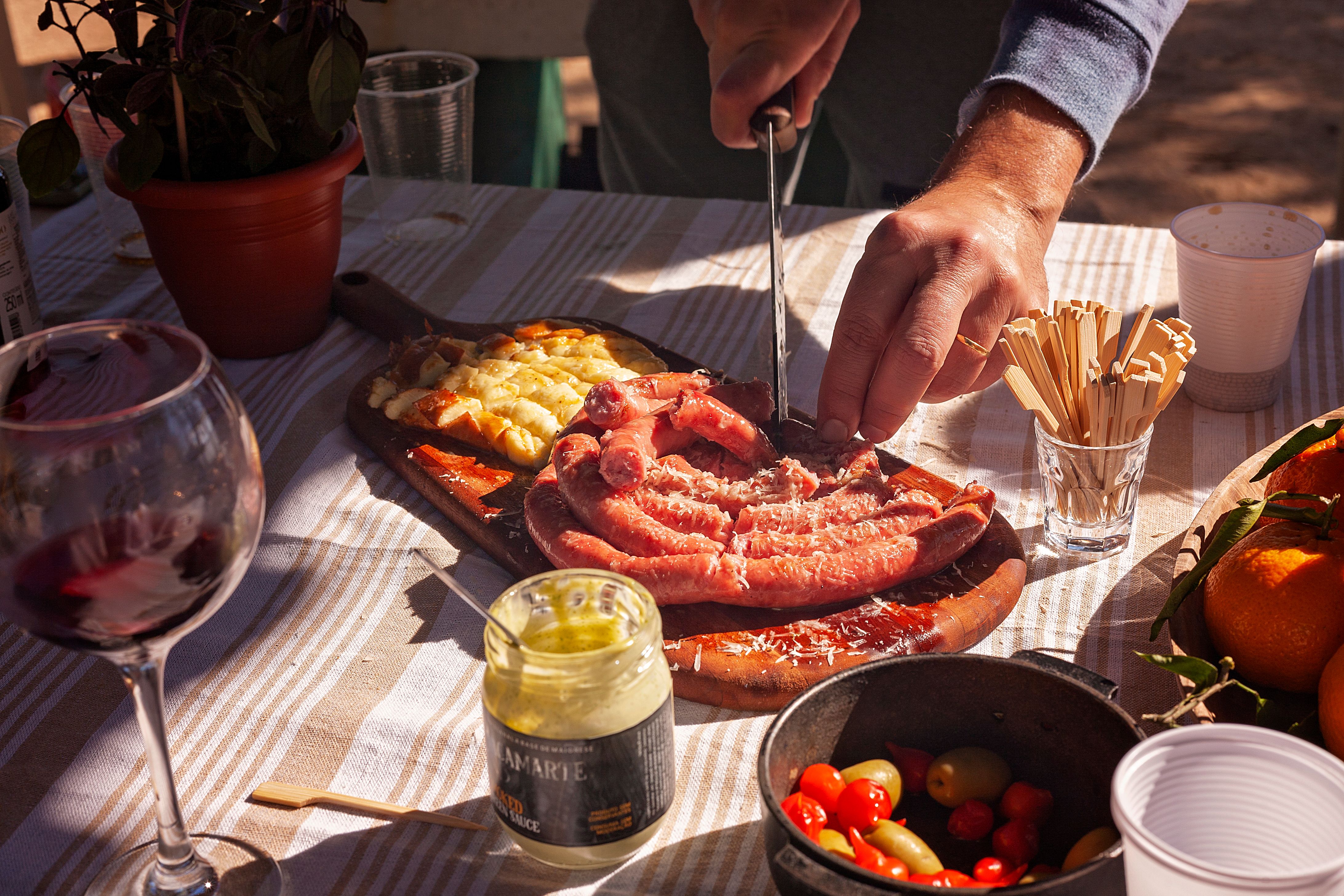 Man Serving Food on Table in Nature · Free Stock Photo