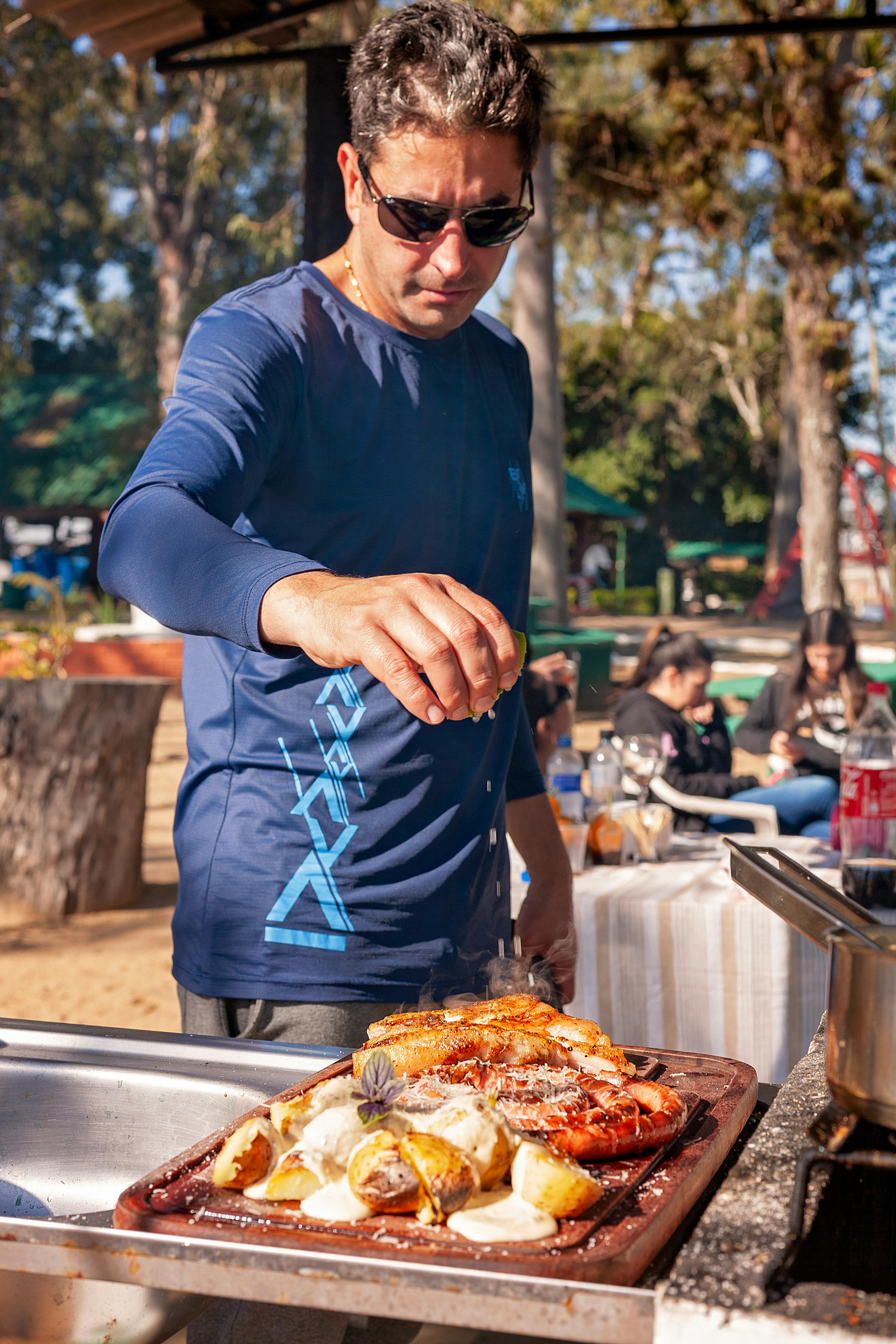 Man Cooking Meat in Forest · Free Stock Photo