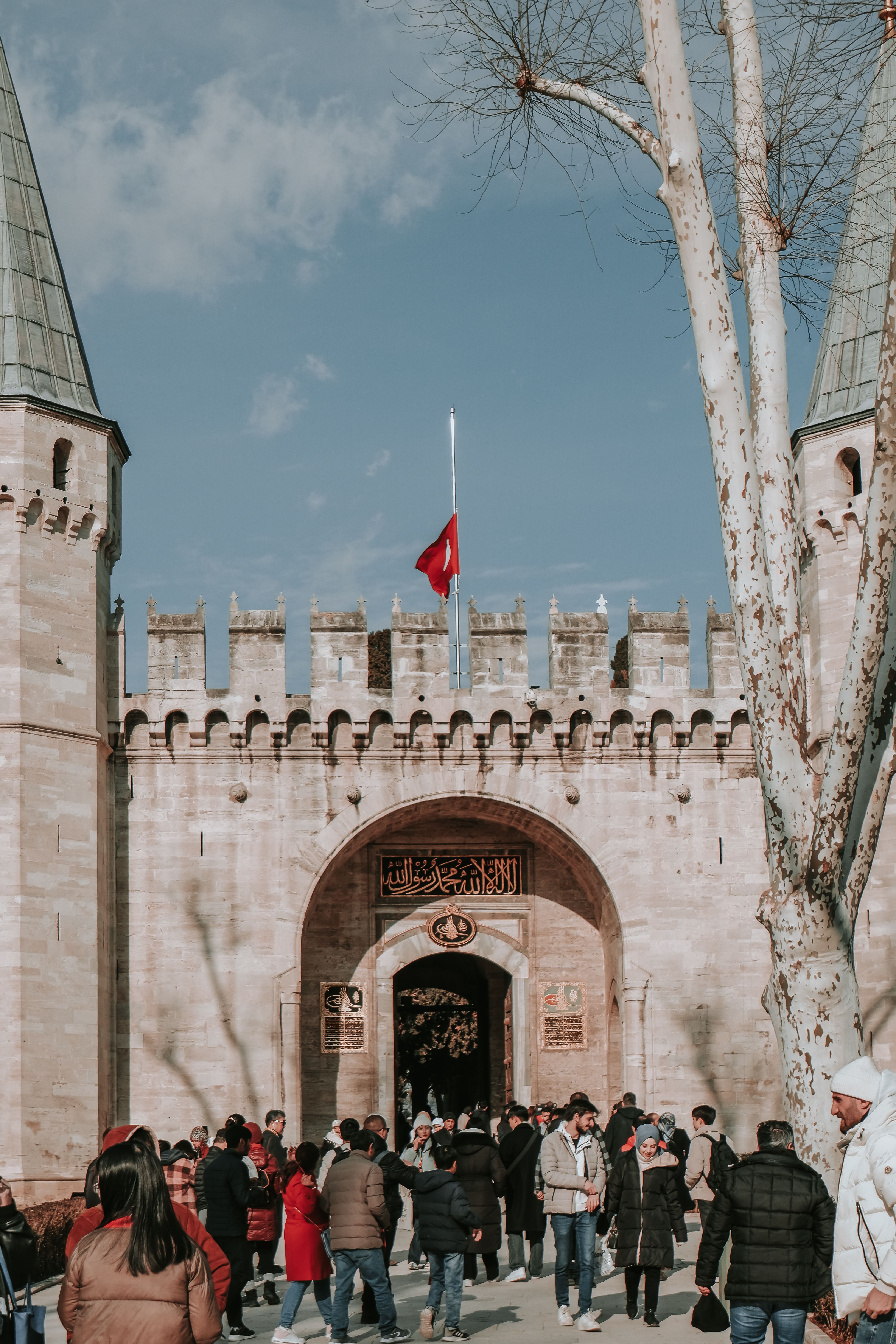 People walking through a gate in a castle · Free Stock Photo