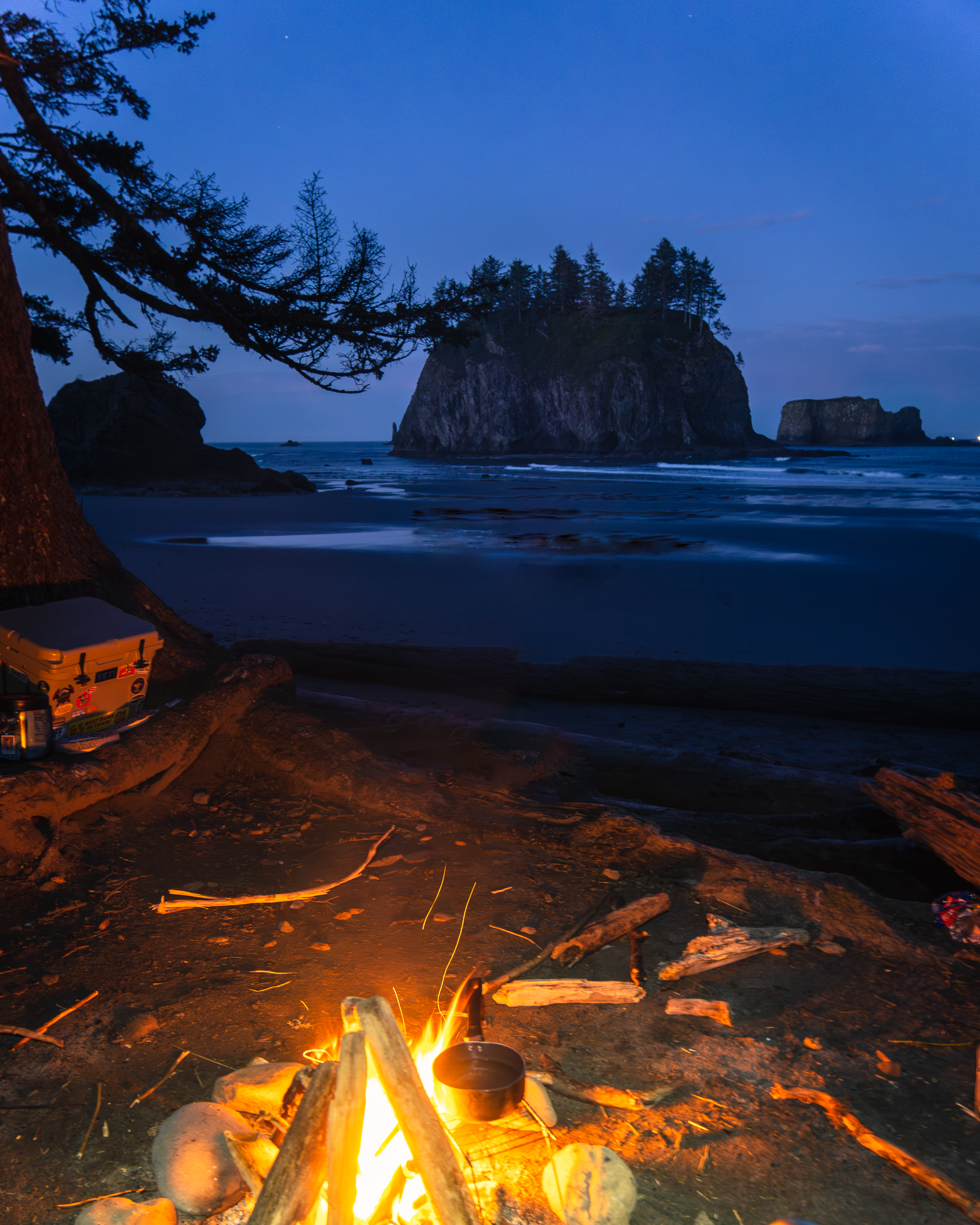 A Campfire on a Beach with View of Rock Formations · Free Stock Photo