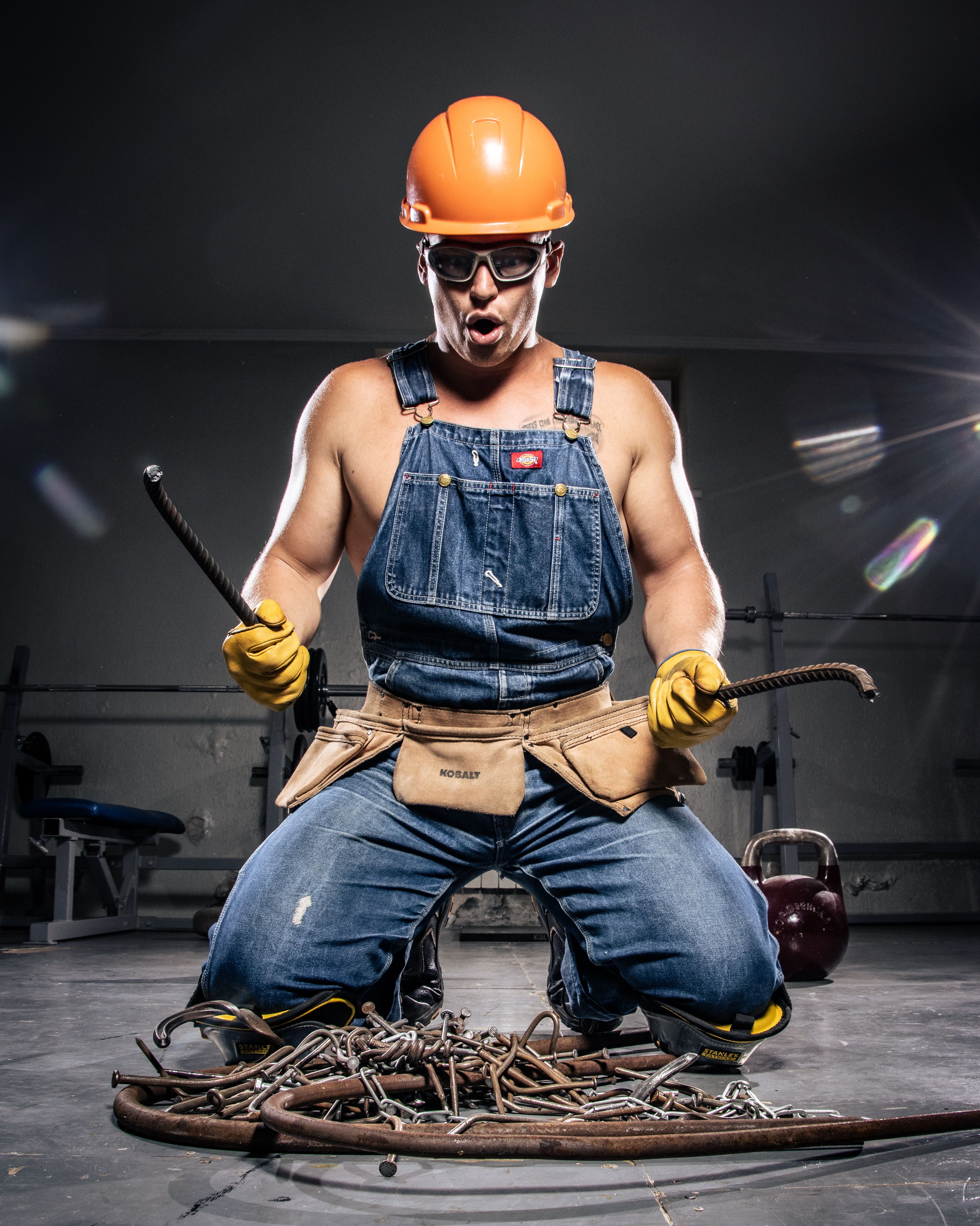 Man Kneeling and Holding Bars · Free Stock Photo