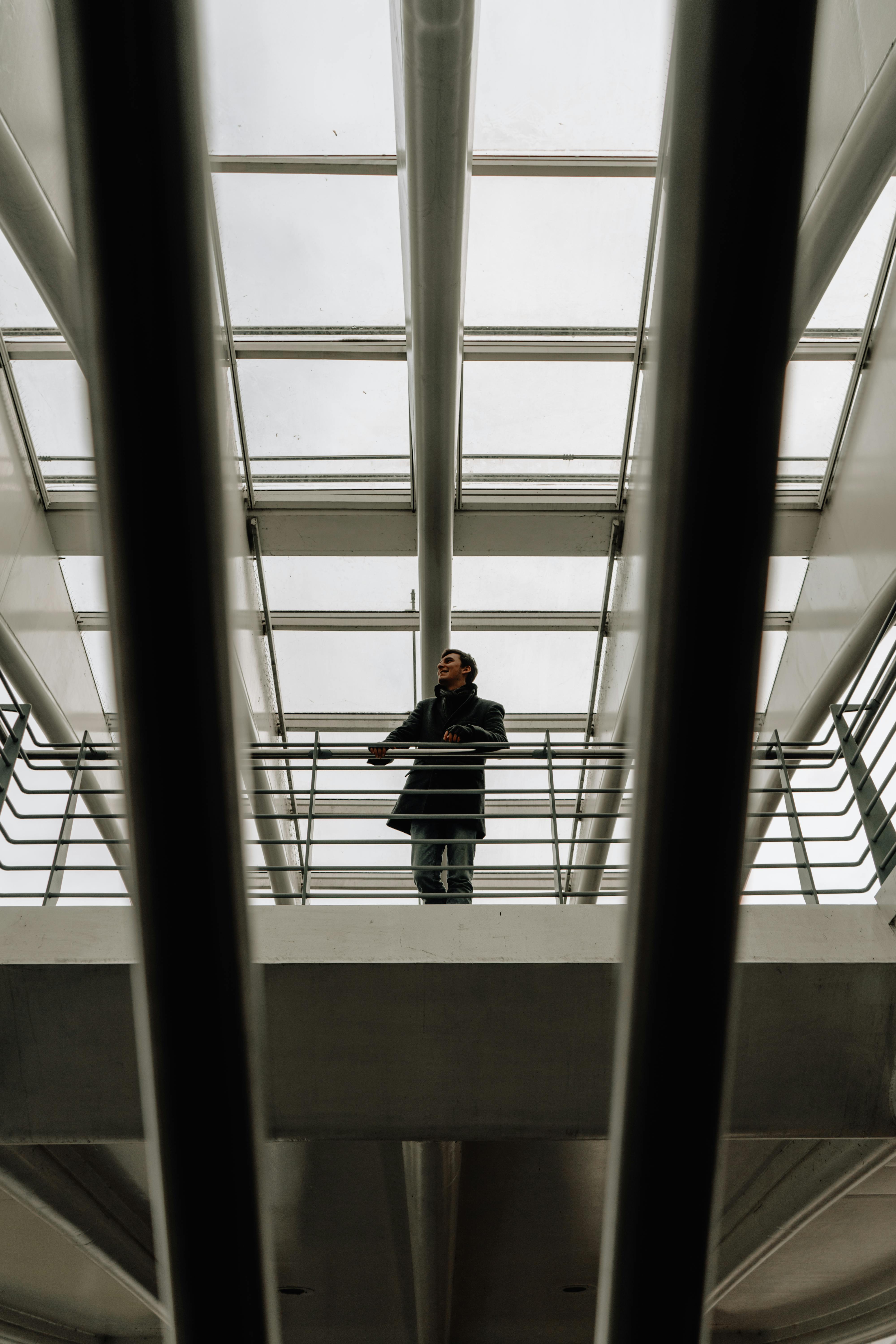 Person Standing on Metal Railings · Free Stock Photo