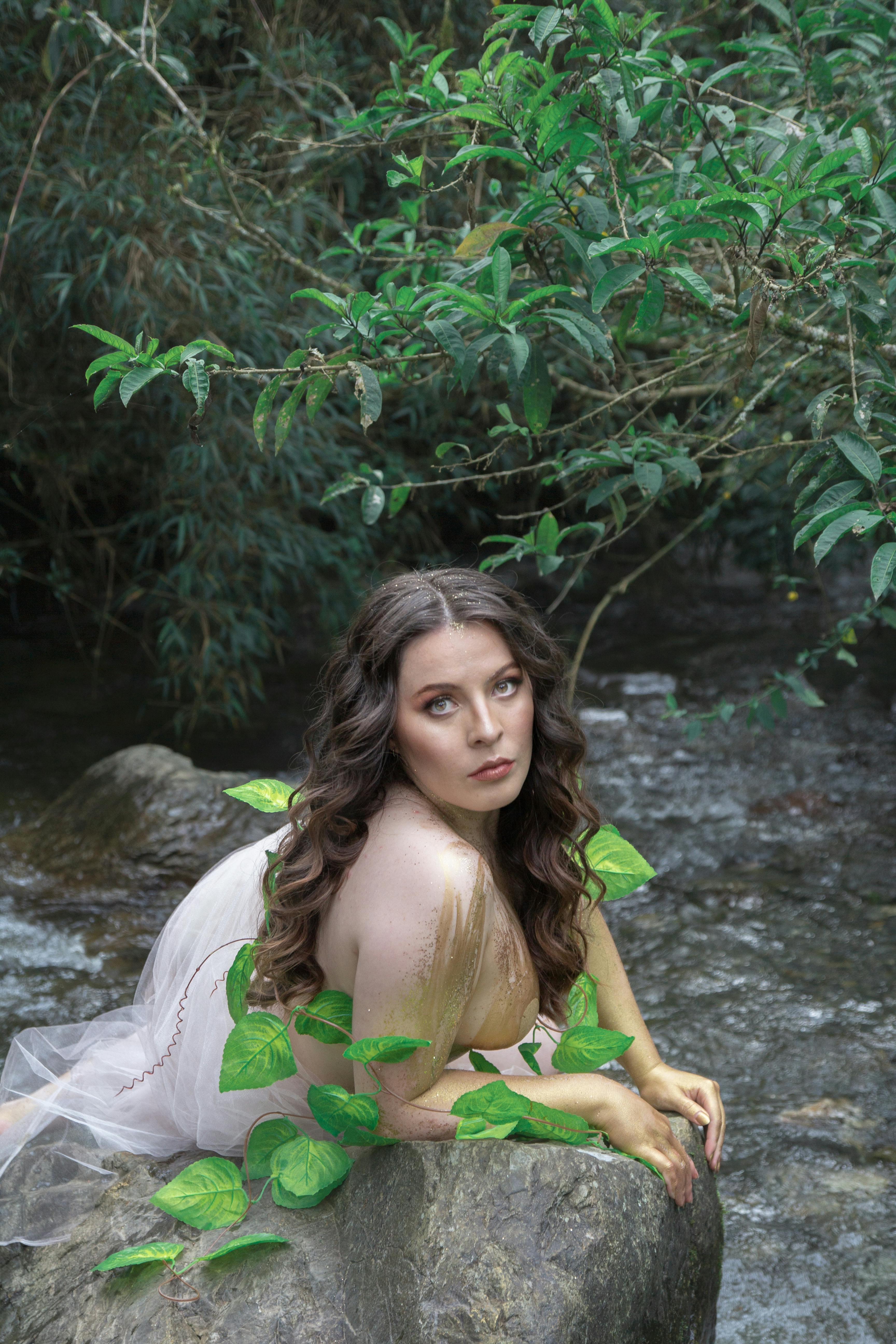 Woman Wrapped in Ivy Lying on a Rock in the River · Free Stock Photo