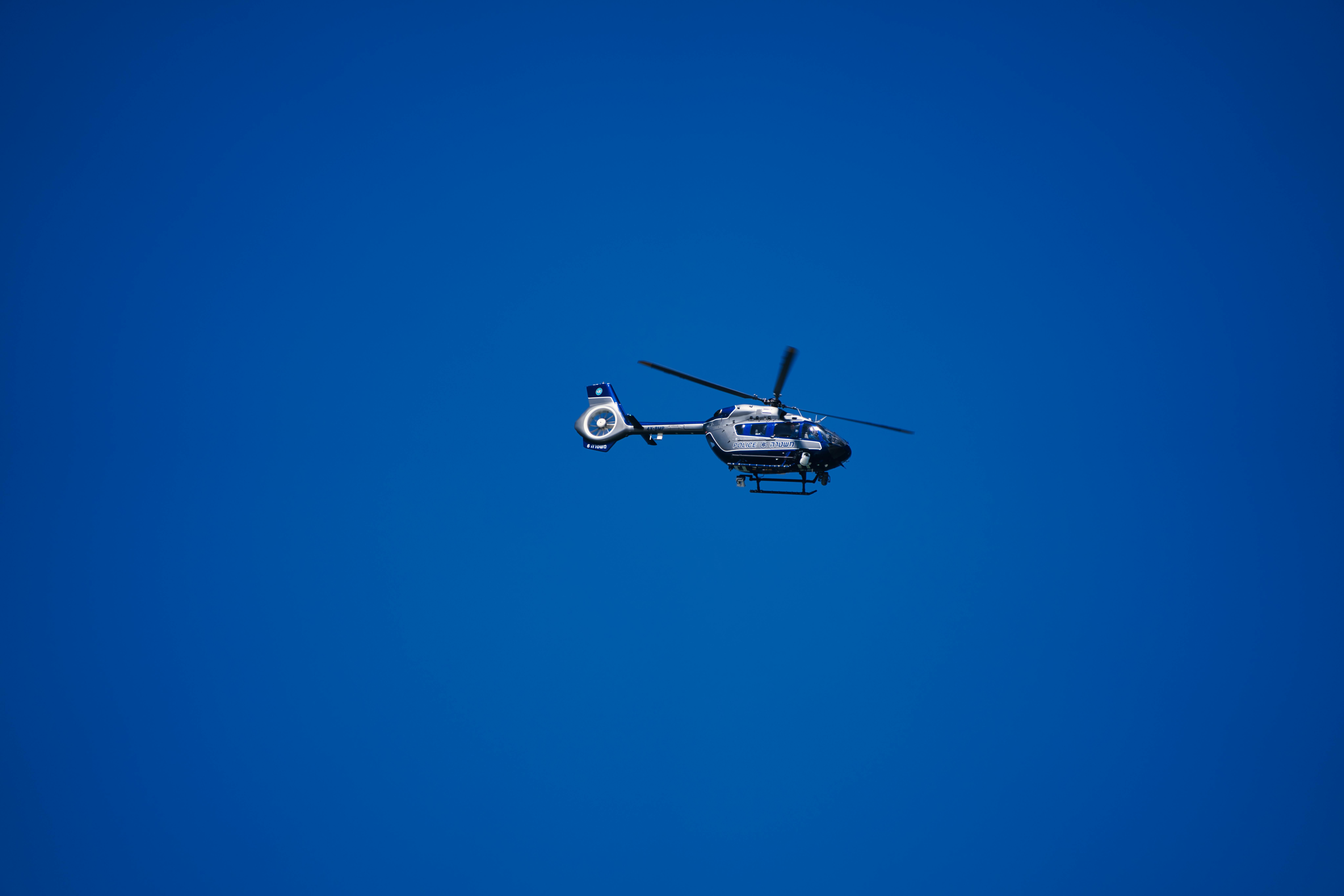 Photography of White and Red Helicopter Flying · Free Stock Photo