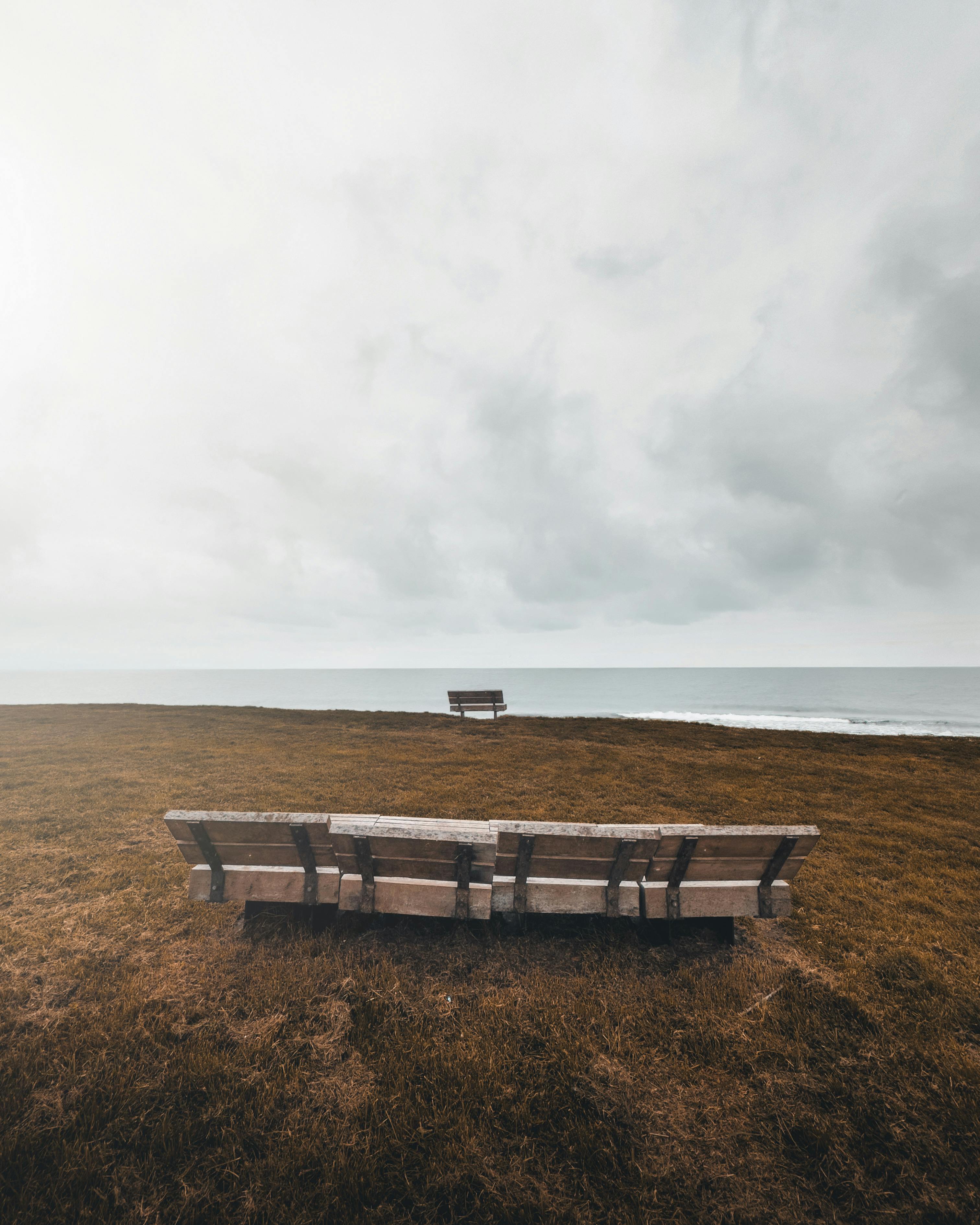 Overcast over Benches on Sea Shore · Free Stock Photo