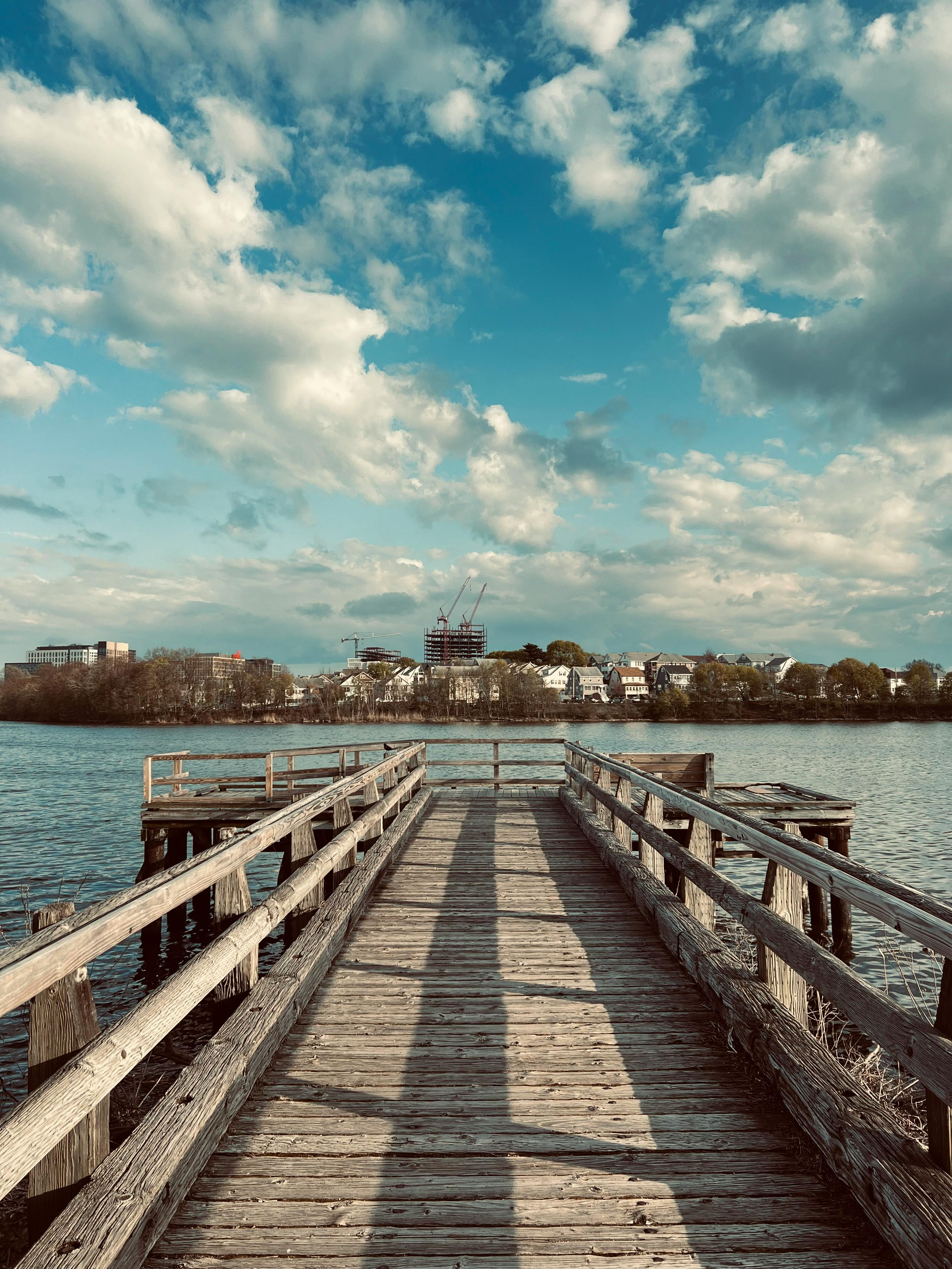Clouds over Wooden Pier on River in Town · Free Stock Photo