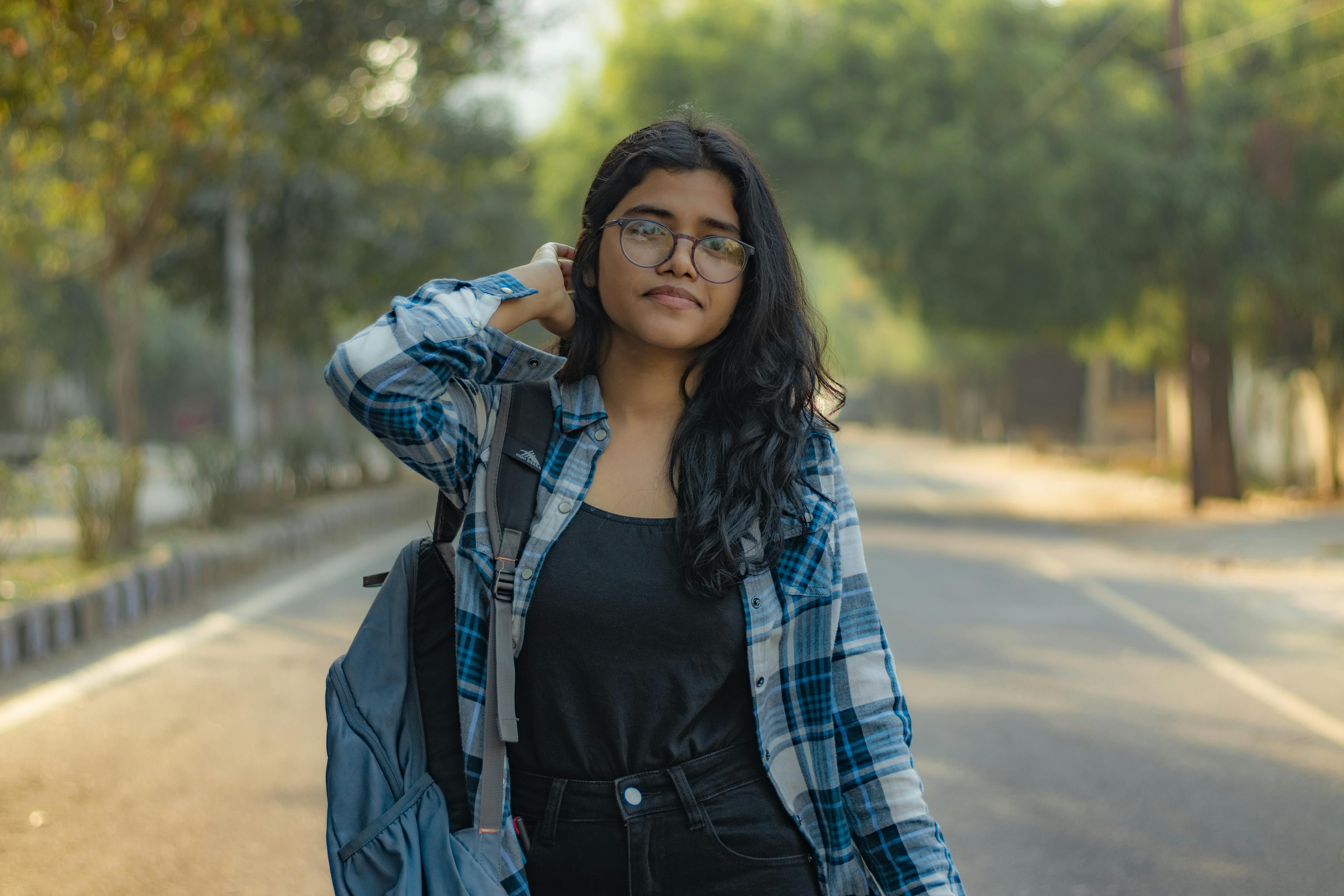 College girl walking with laptop bag. · Free Stock Photo
