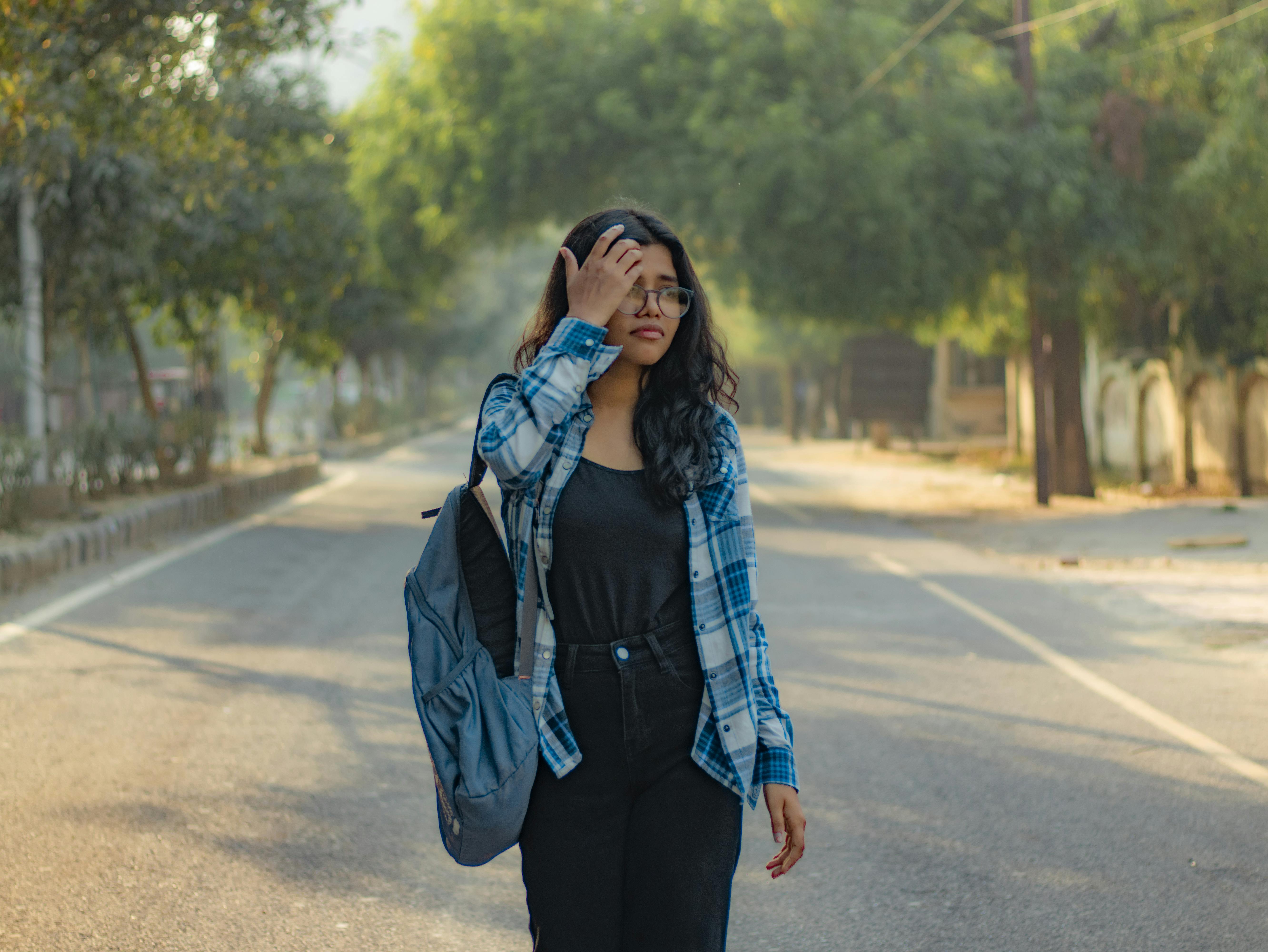 College girl walking with laptop bag. · Free Stock Photo