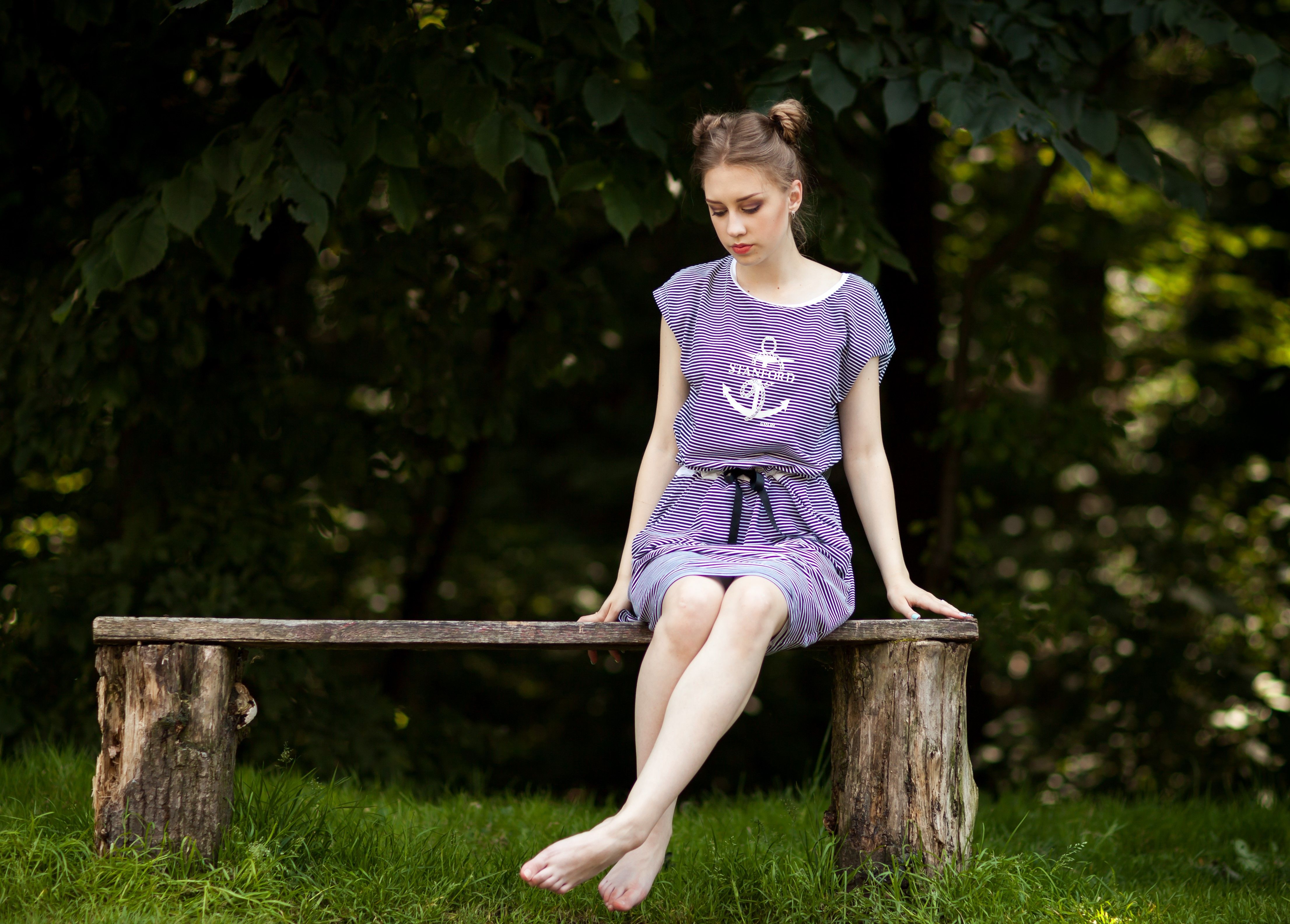 Brunette Woman in Dress Sitting Barefoot on Bench · Free Stock Photo