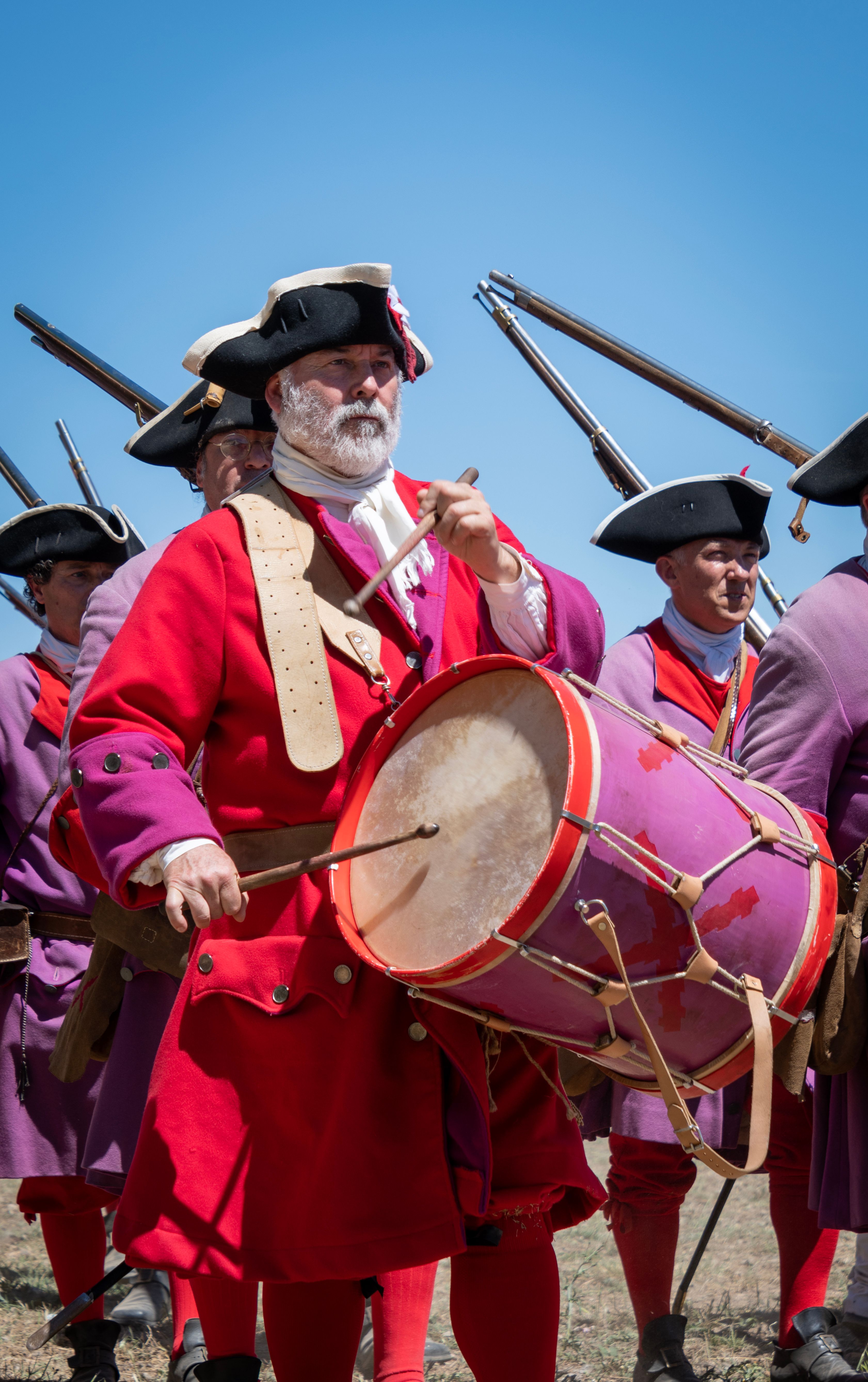A Group of Soldiers in Vintage Costumes Shooting Guns at a Festival ...