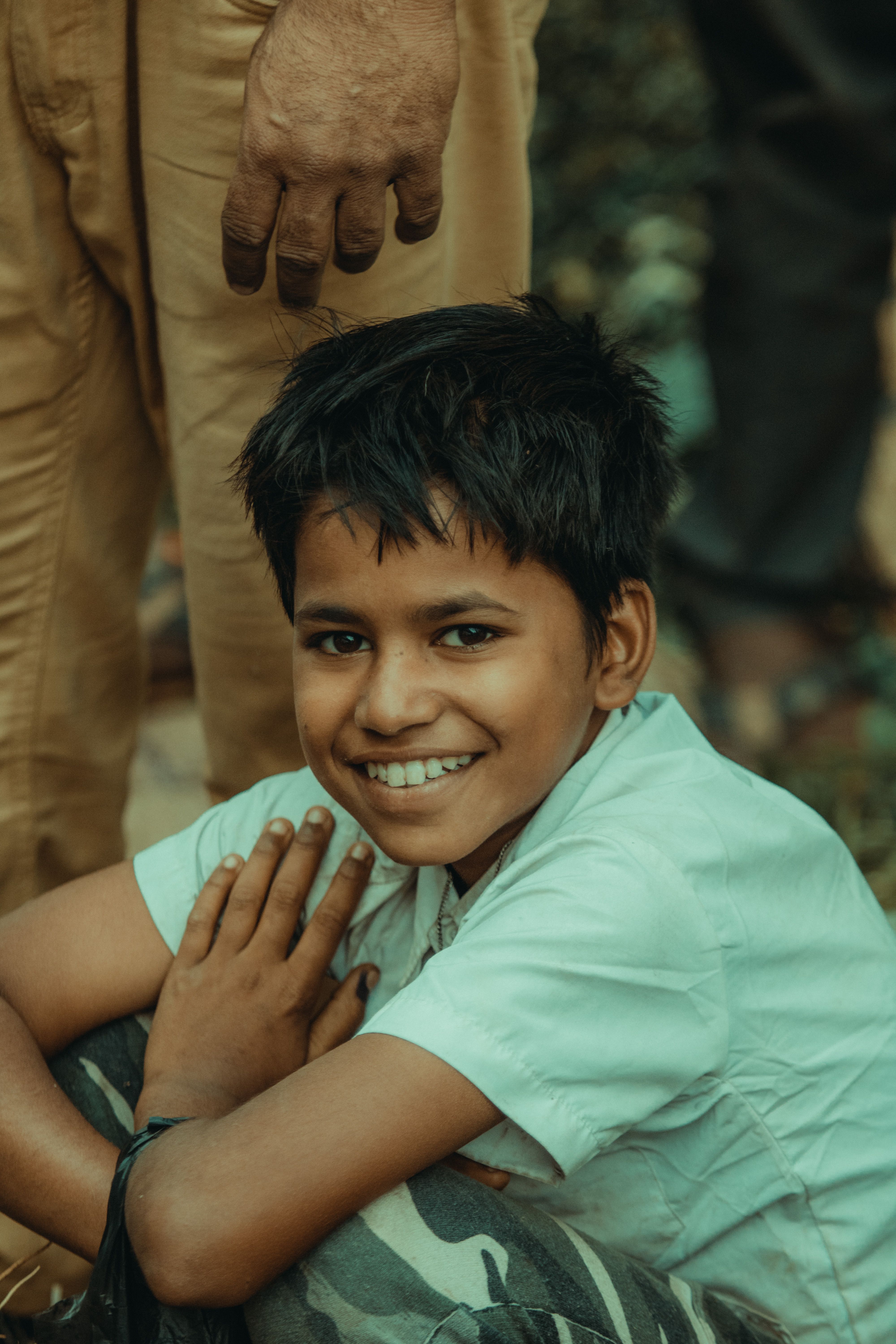 Crouching Smiling Boy · Free Stock Photo
