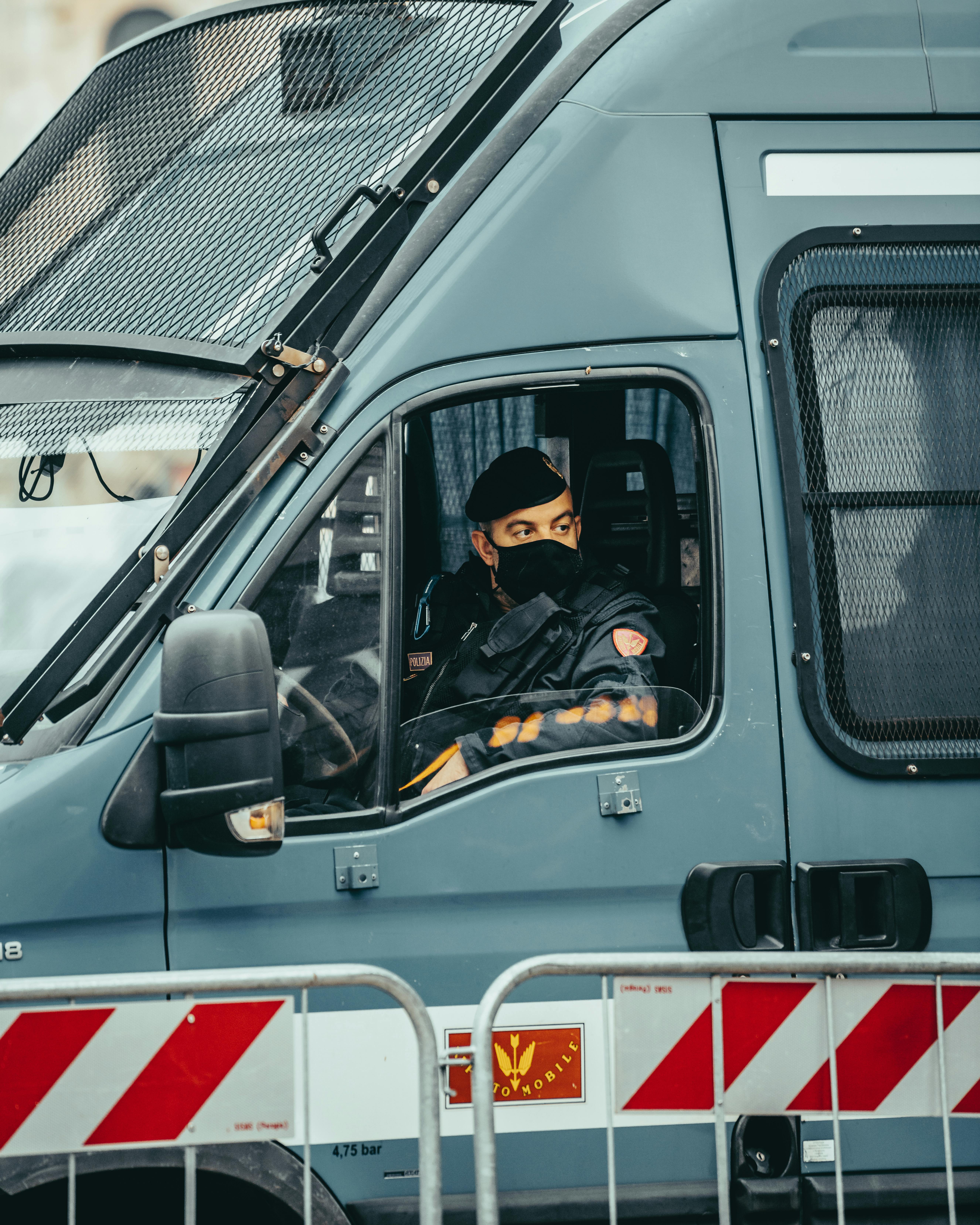 Photo of a Man in a Van, Wearing a Uniform and a Face Mask · Free Stock ...