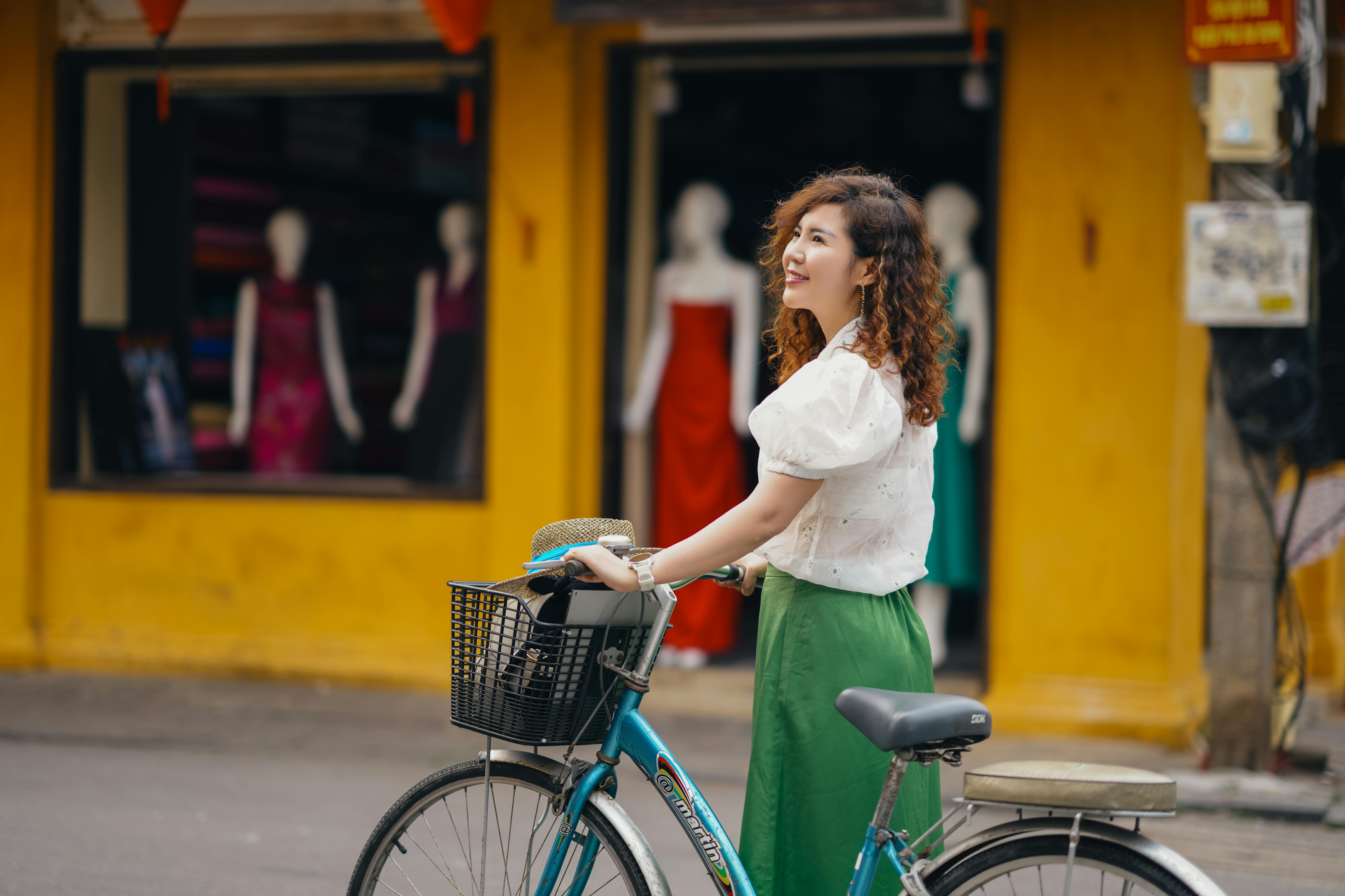 Person Pushing a Bicycle with a Basket · Free Stock Photo