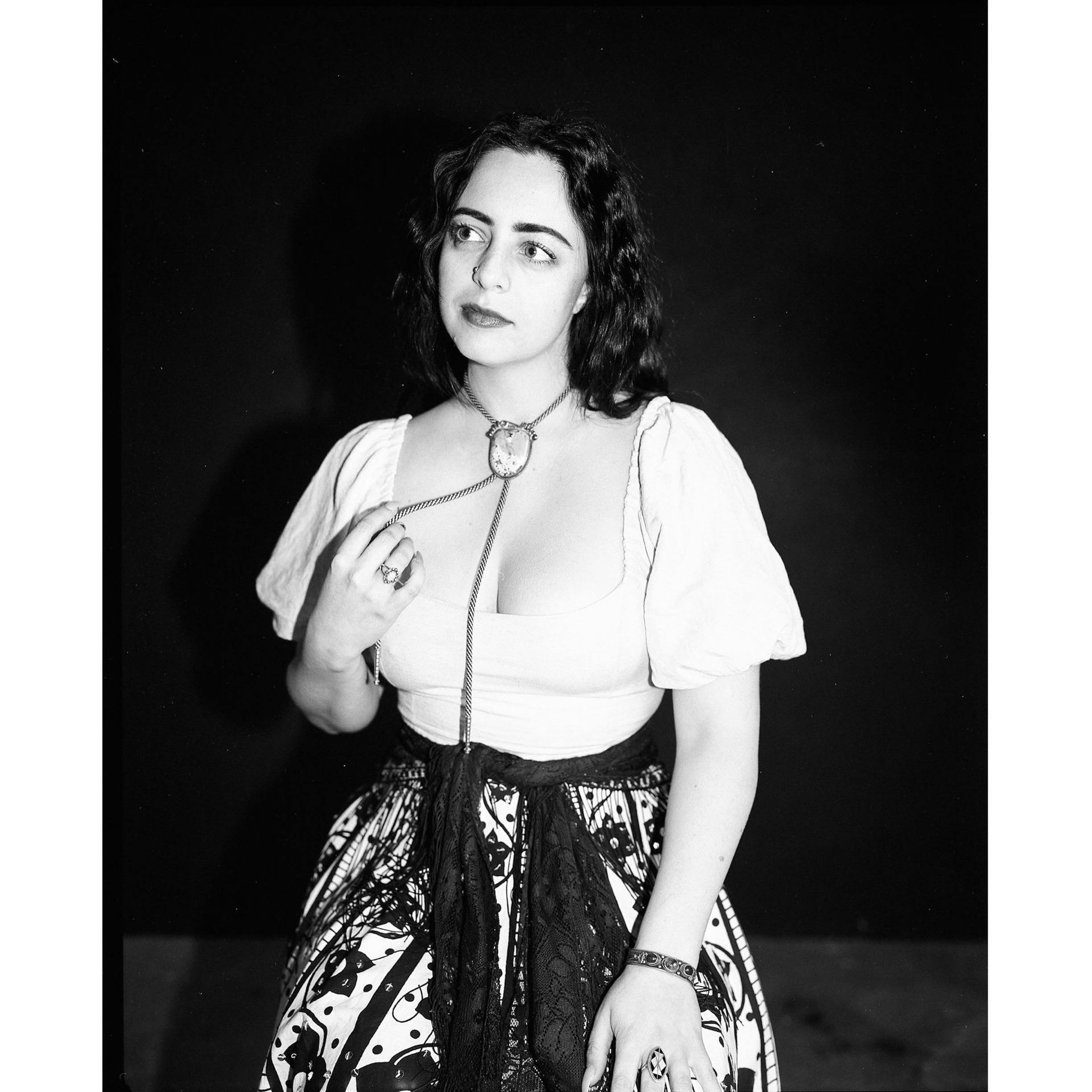 Woman Posing In Black Crop Top Mini Skirt And High Platform Boots
