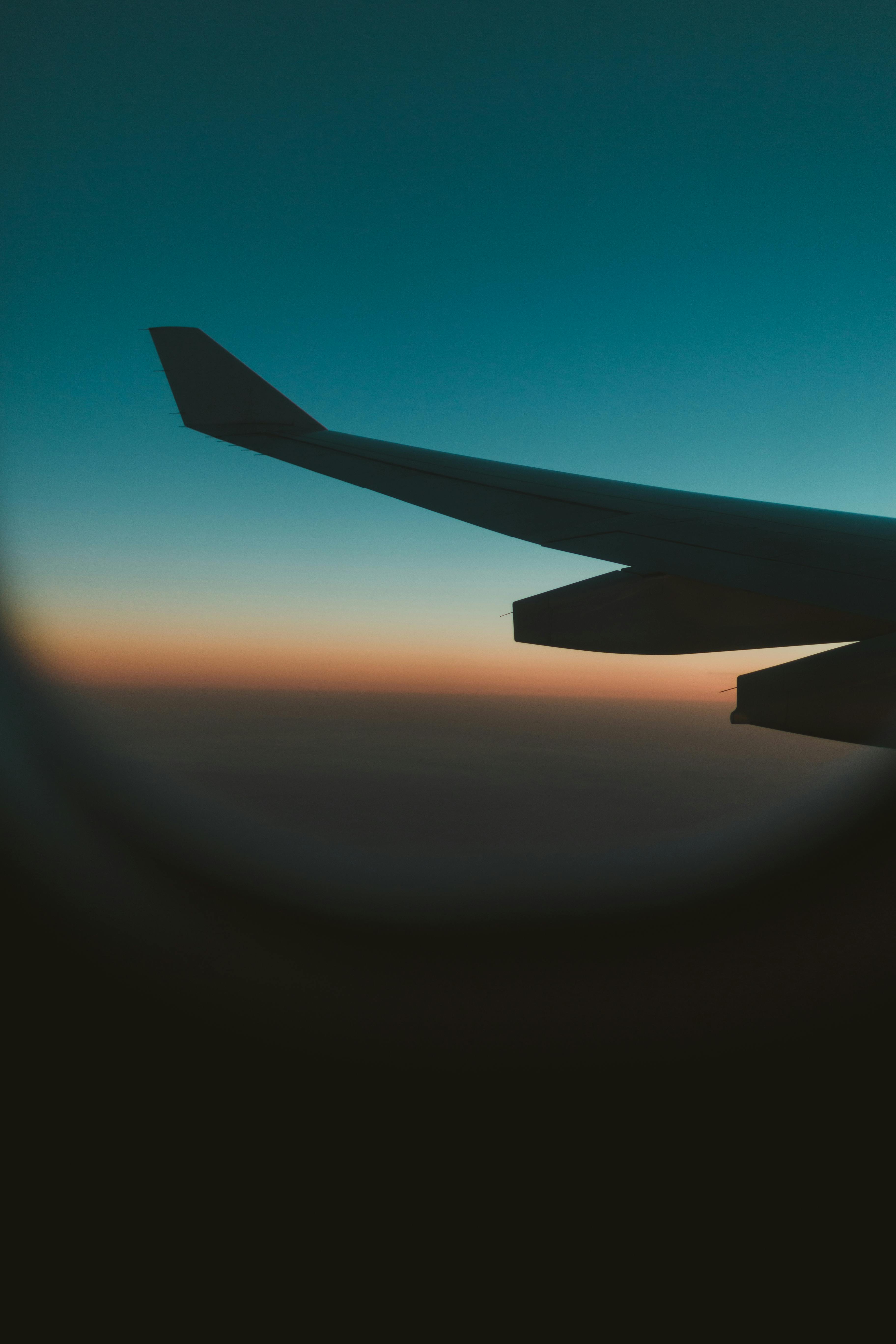 Airplane Wing during Flight at Sunset · Free Stock Photo