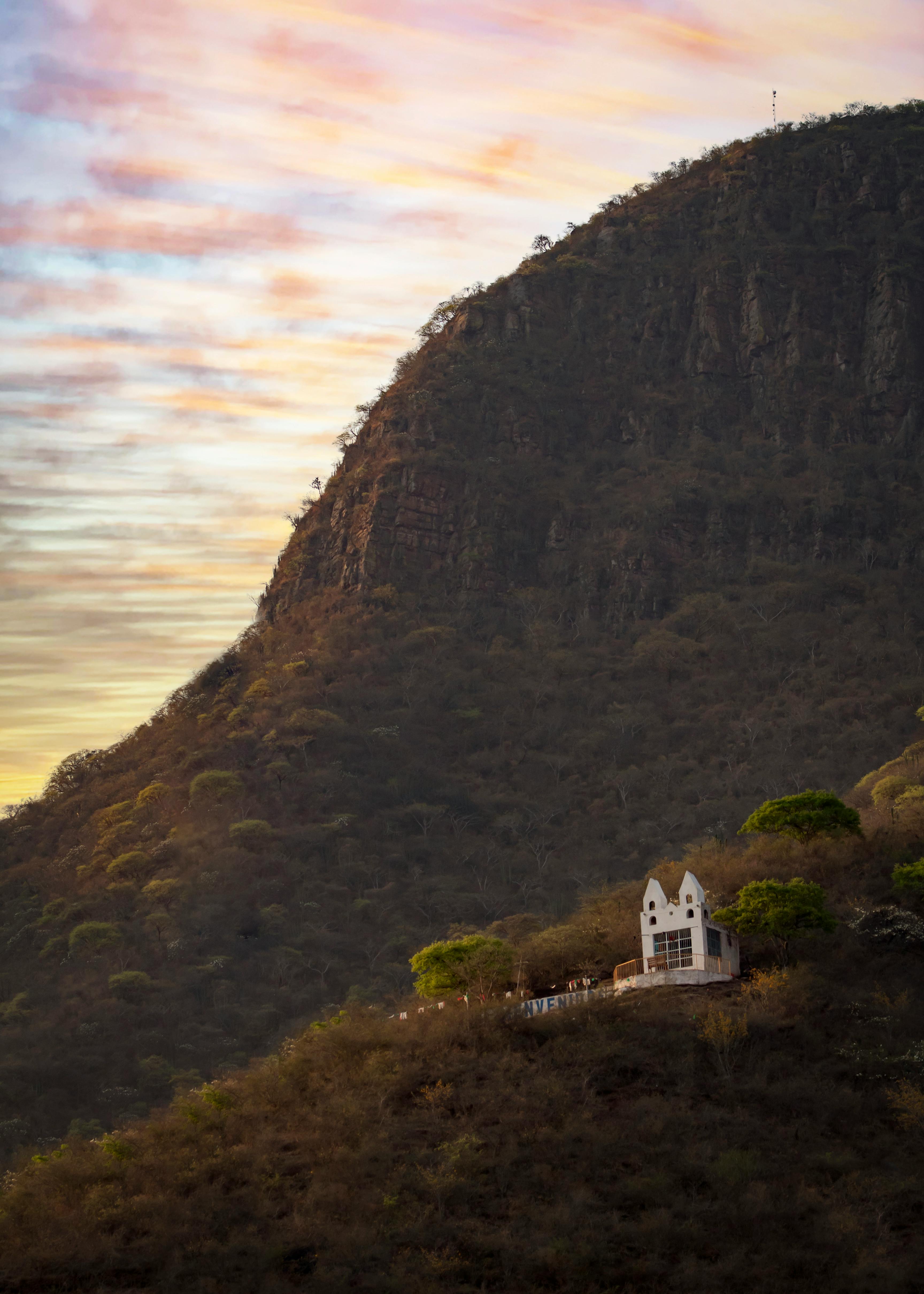 Building under Hill in Countryside · Free Stock Photo