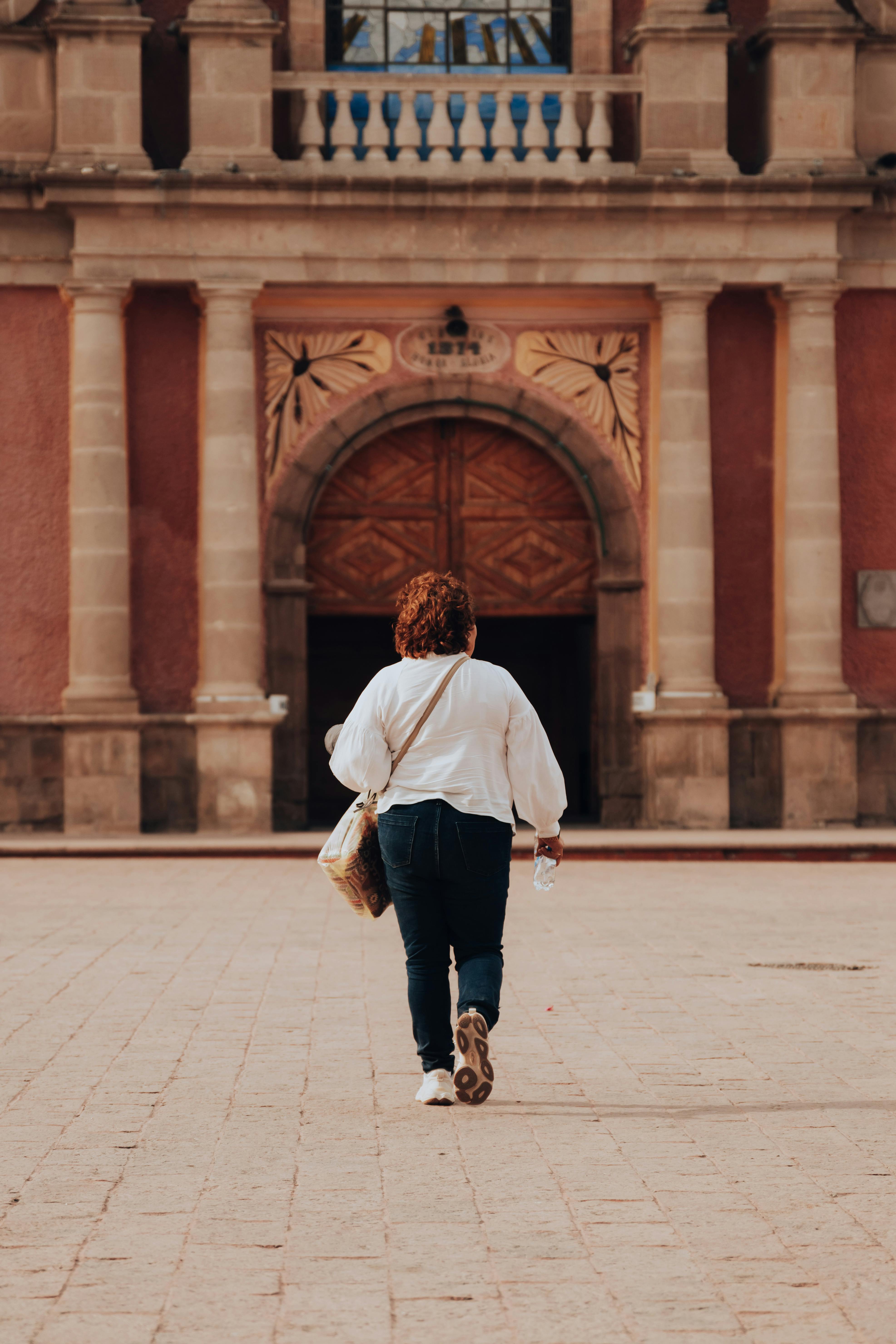 Woman Walking towards Building · Free Stock Photo