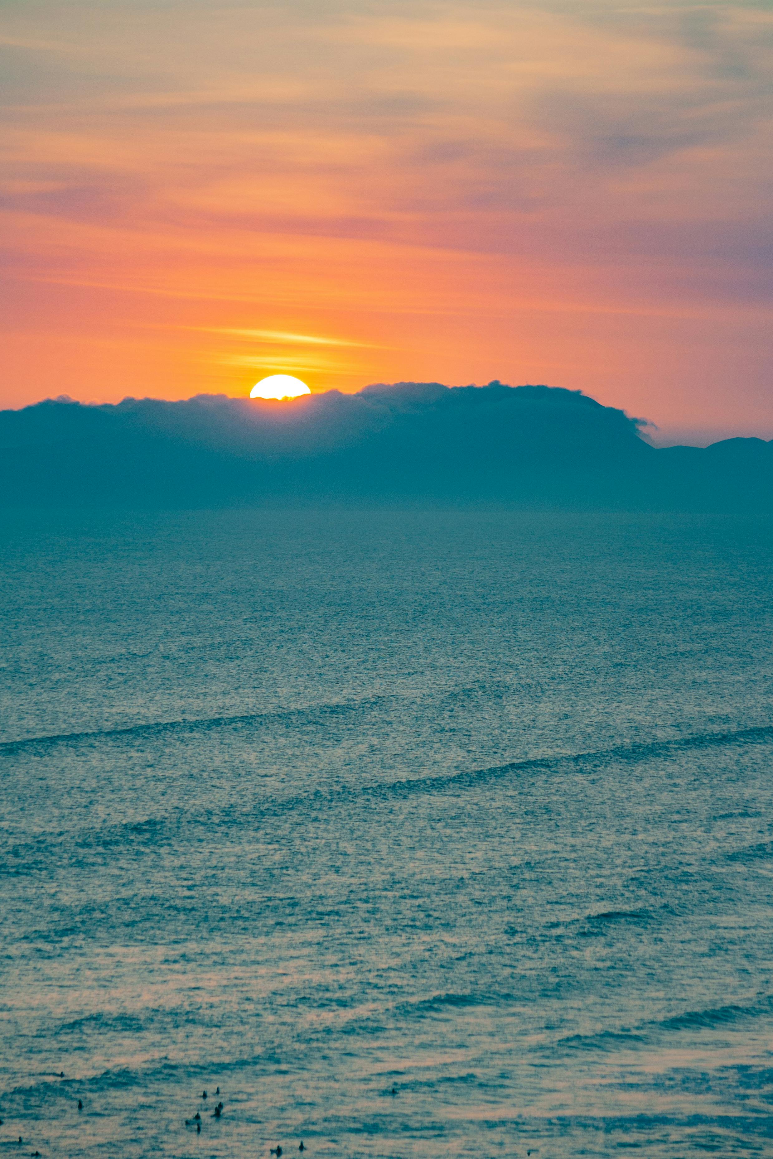 Rocks on Sea Shore in Town at Sunset · Free Stock Photo