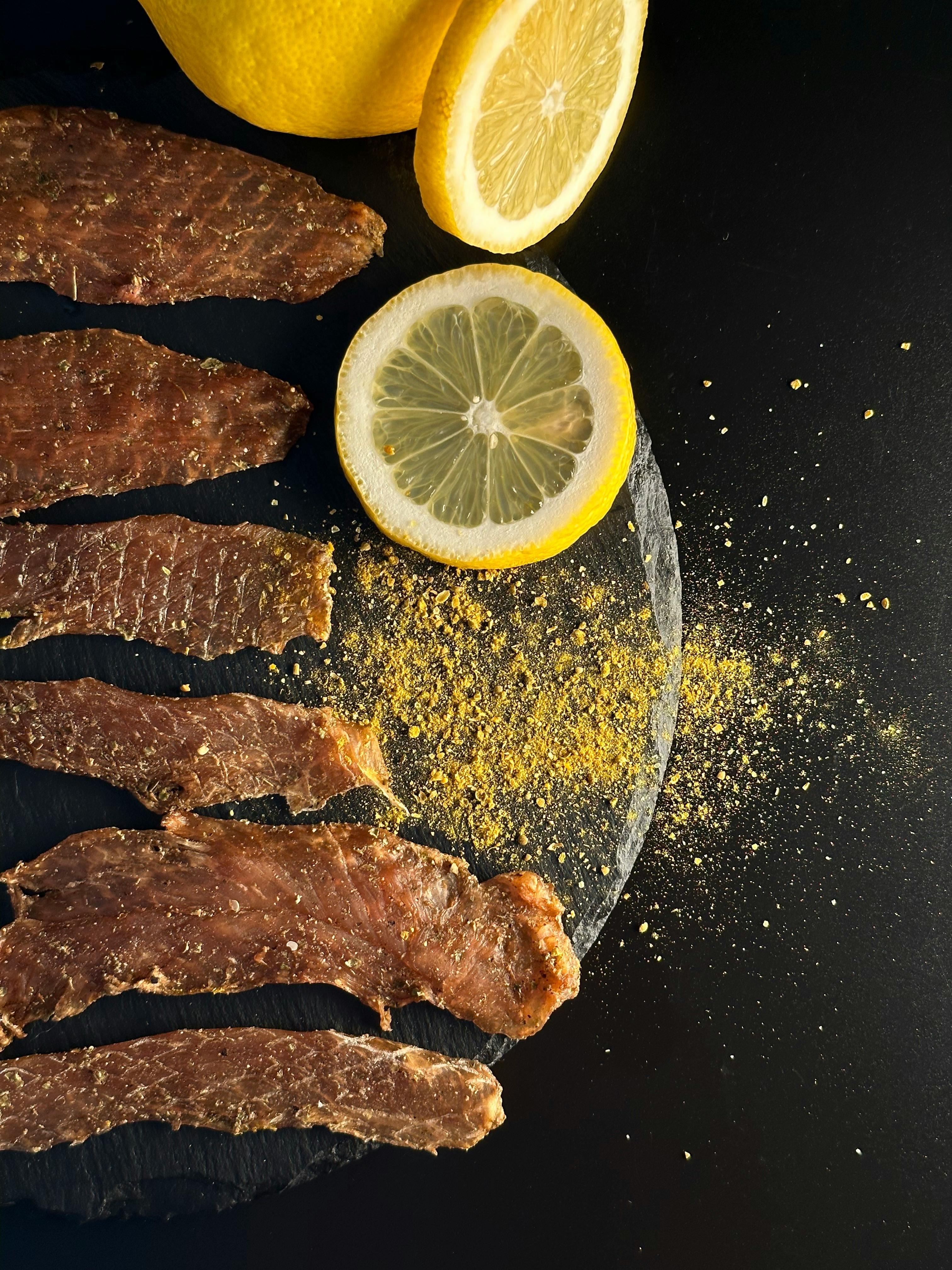 Strips of Meat Sprinkled with Turmeric Powder and Served with Lemon ...