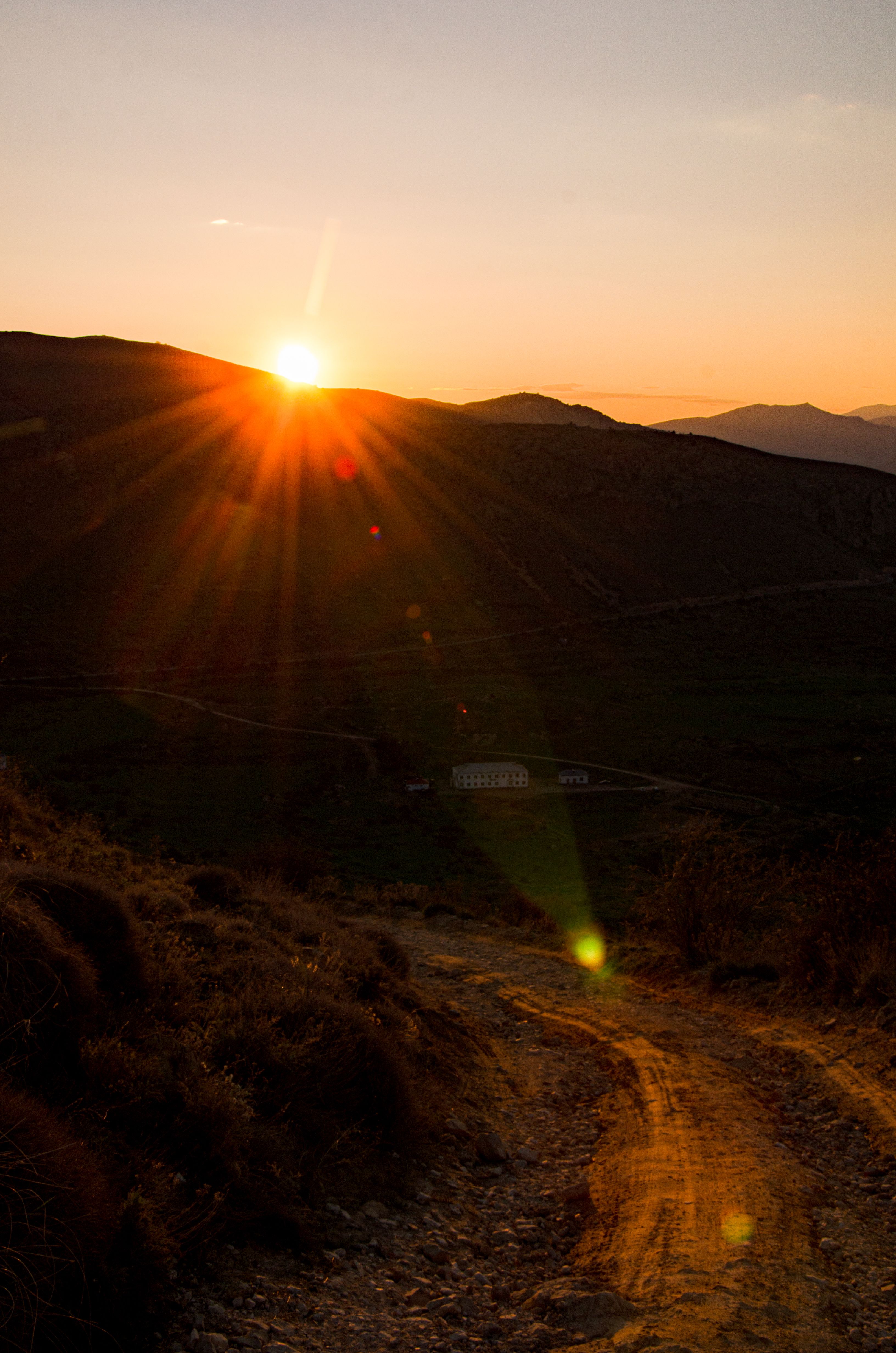 Sunlight over Hill over Dirt Road · Free Stock Photo