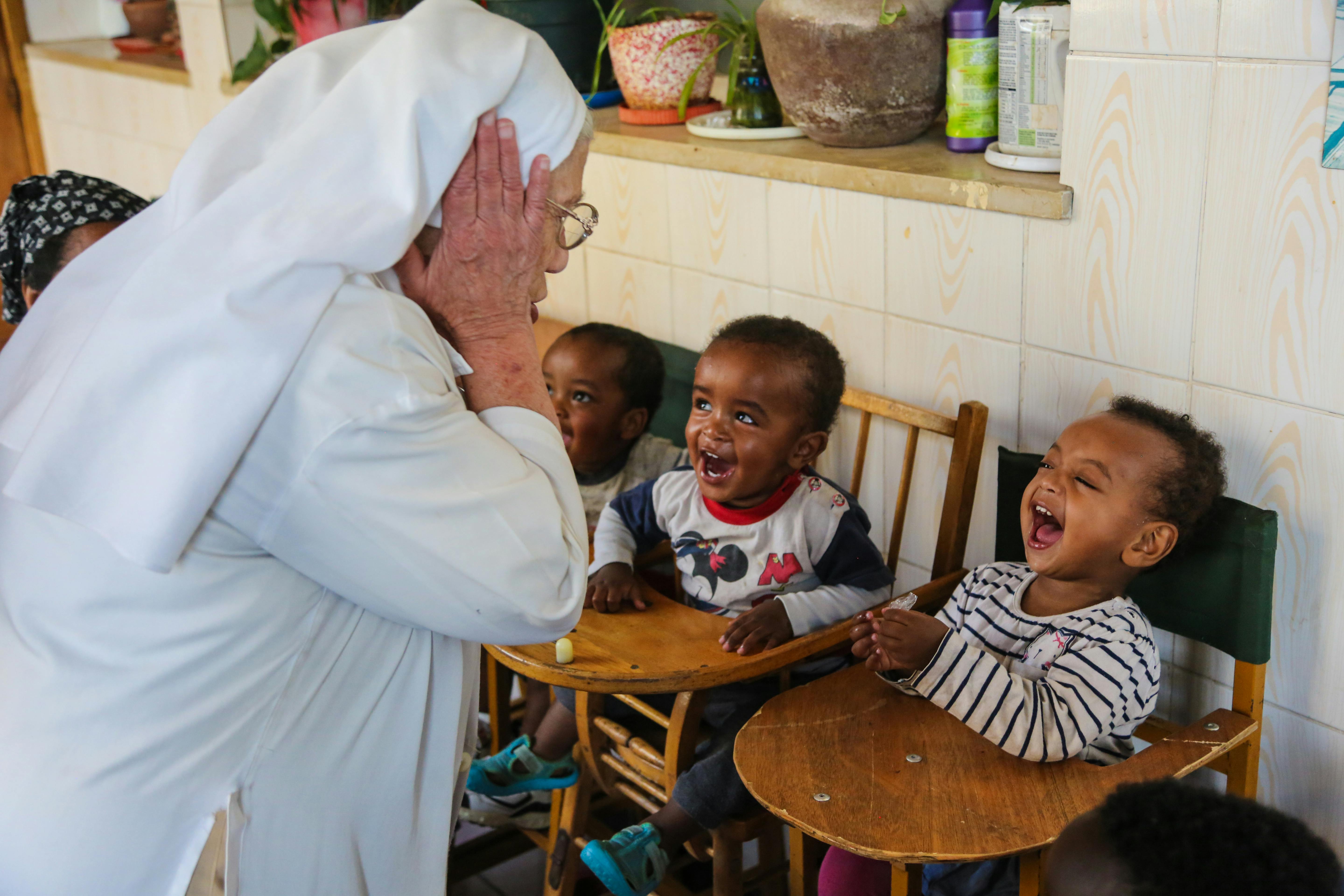 Nun Playing with Children · Free Stock Photo