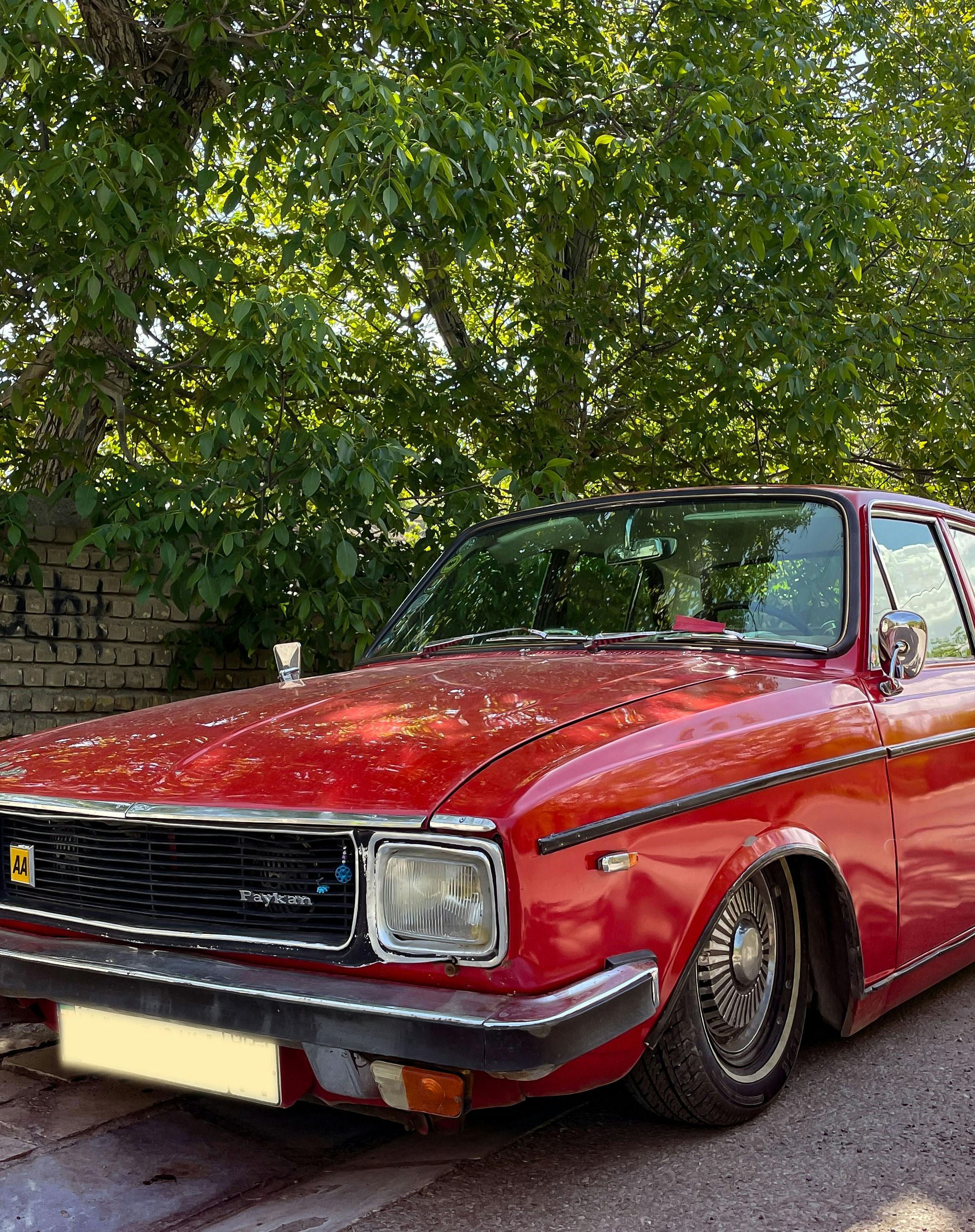 Red Paykan Deluxe Parked on the Street · Free Stock Photo