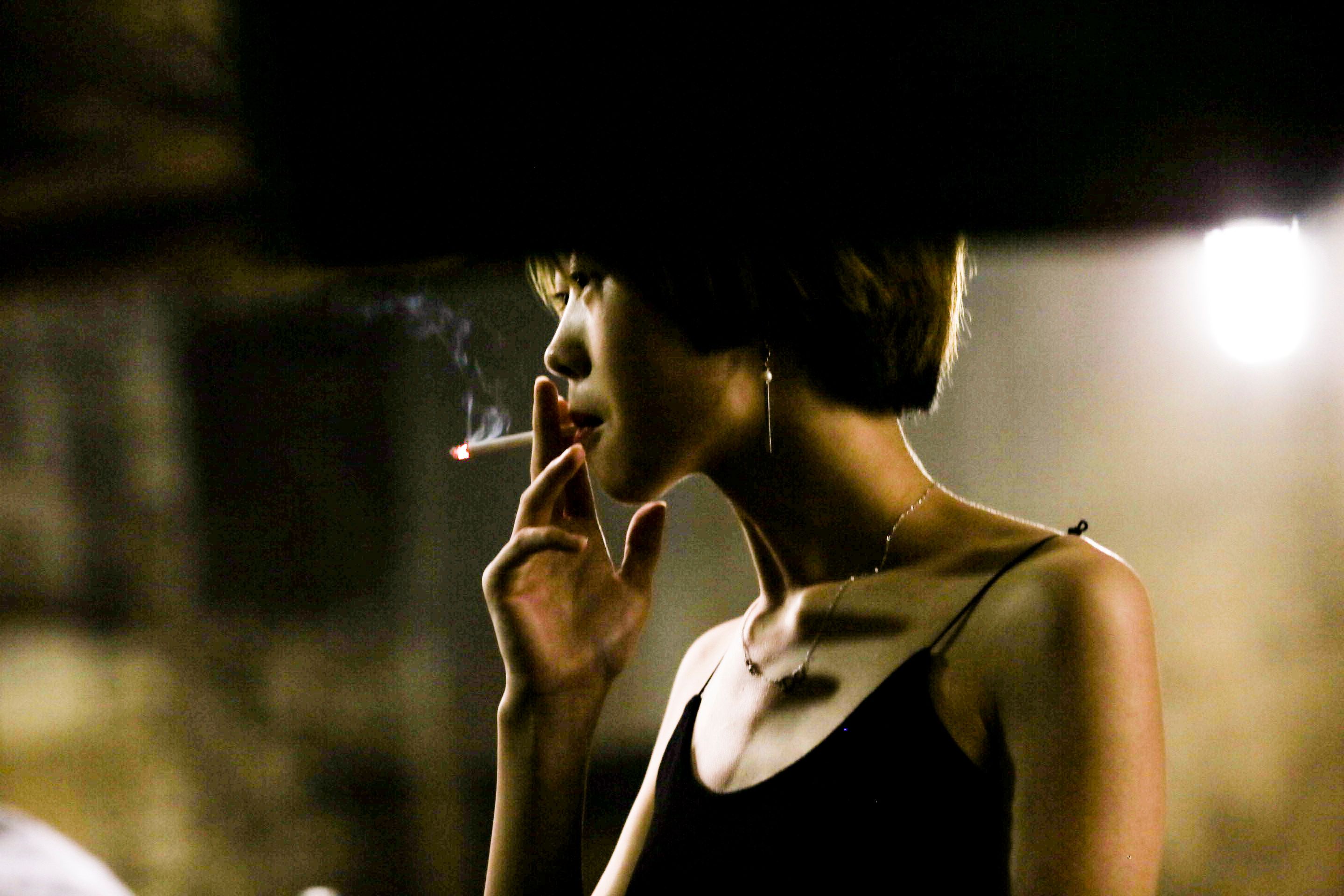 Young Woman Smoking a Cigarette · Free Stock Photo