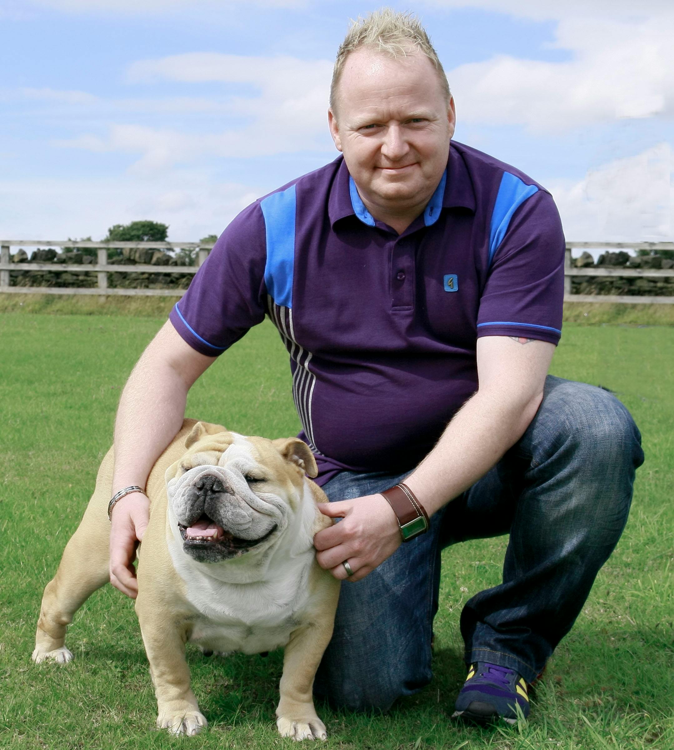 Man Crouching and Posing with Bull Dog · Free Stock Photo