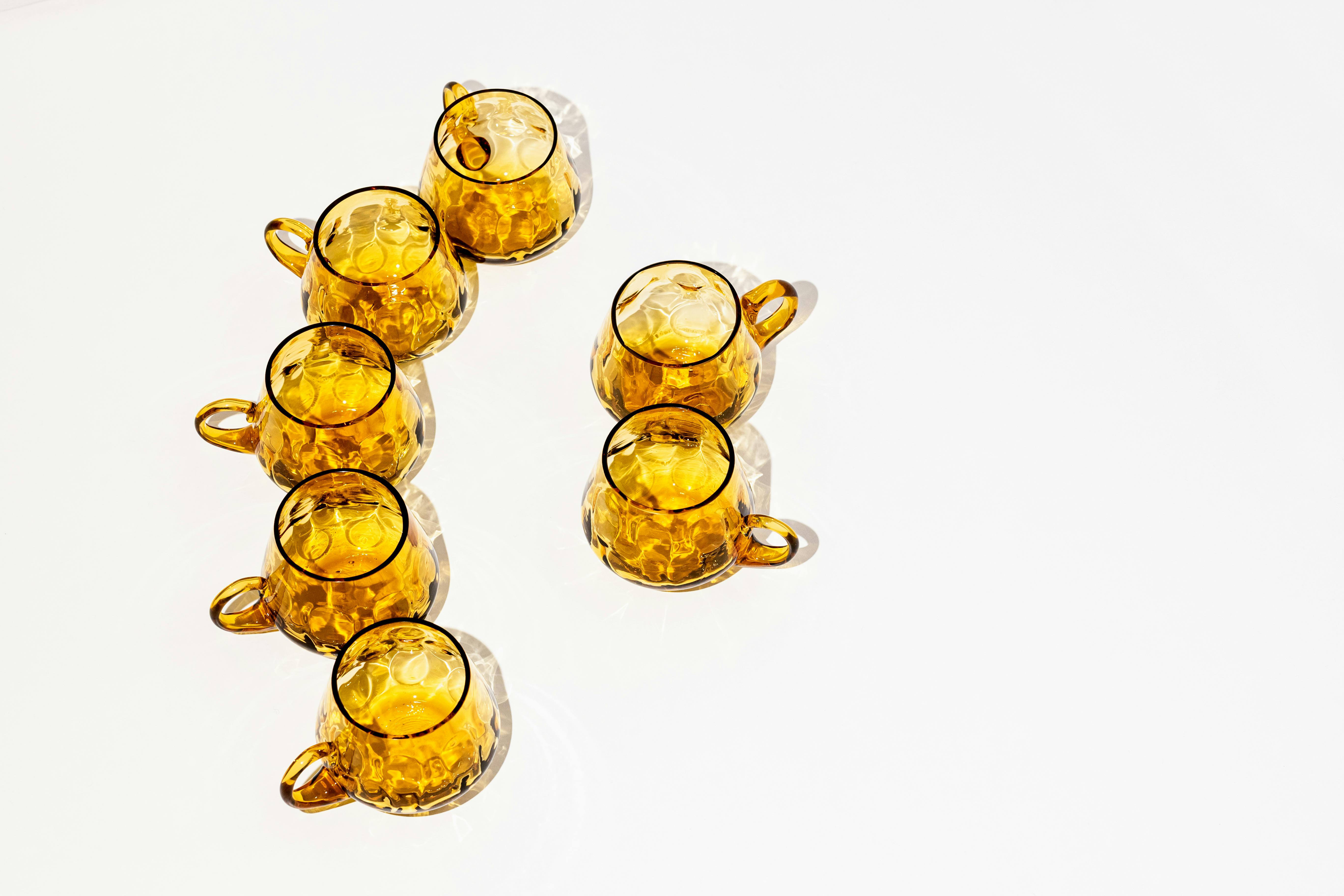 Golden glass cups with interesting dark details · Free Stock Photo