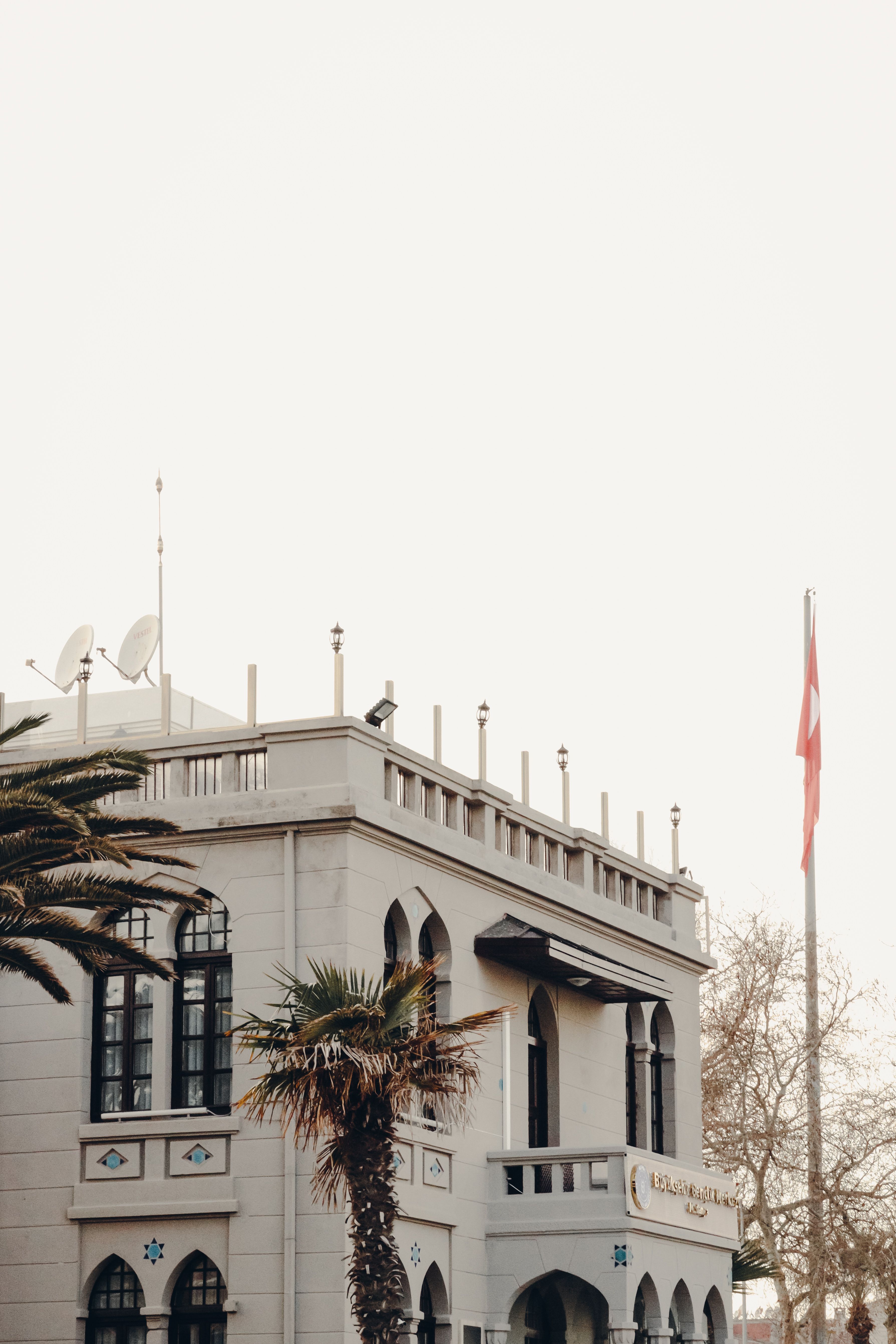 A building with a flag flying in the wind · Free Stock Photo
