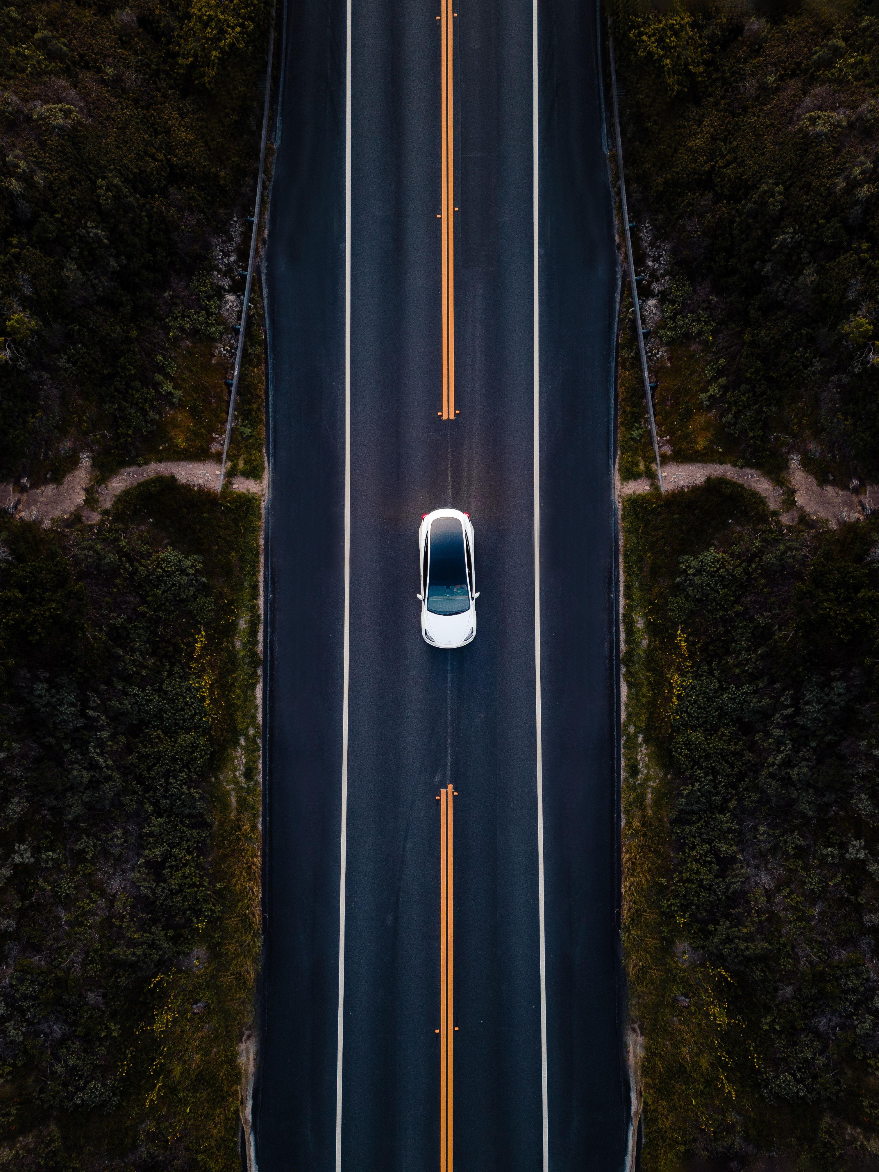 Symmetrical aerial Footage of a Car on a Road · Free Stock Photo