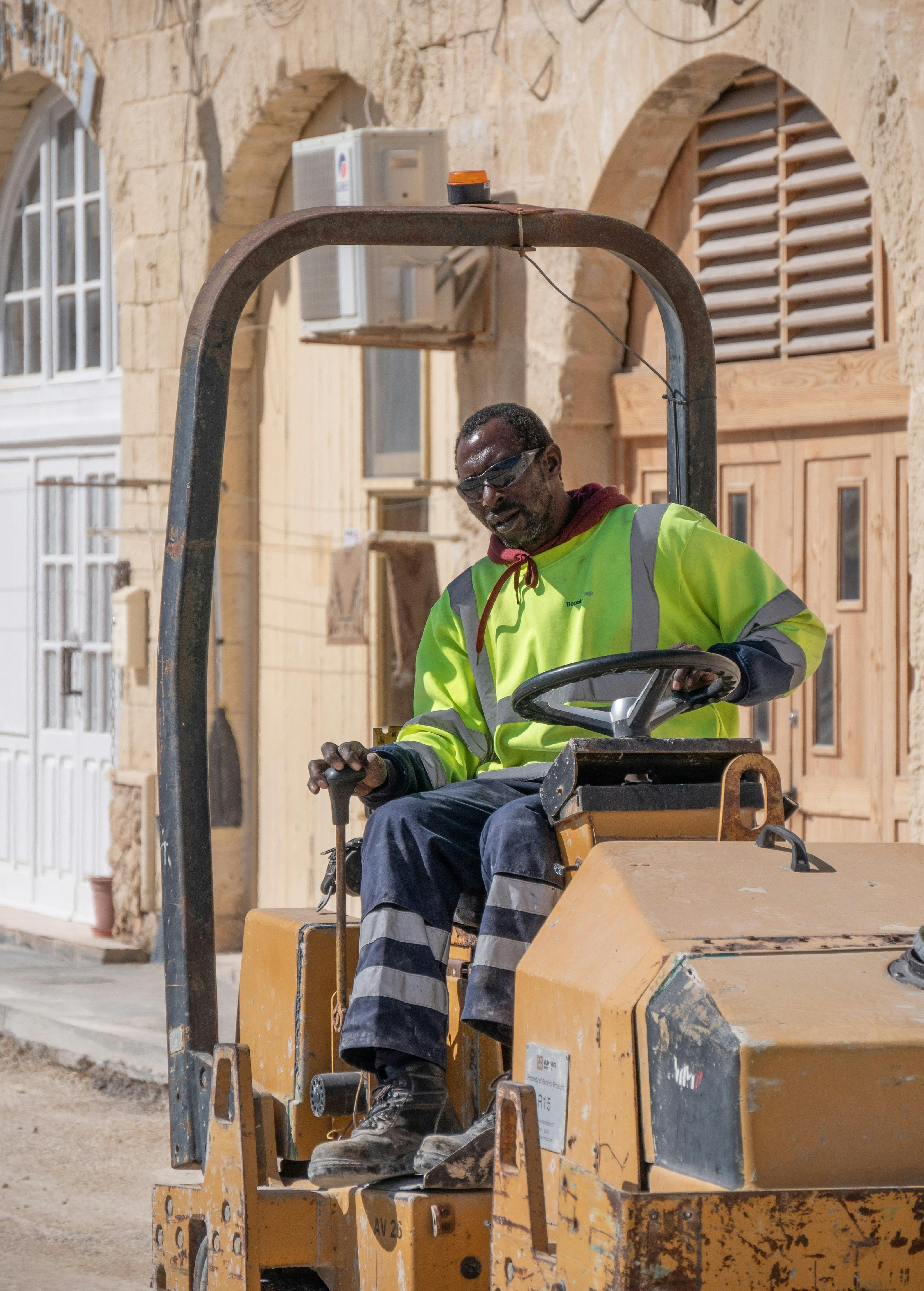 Man Sitting on Construction Machine · Free Stock Photo