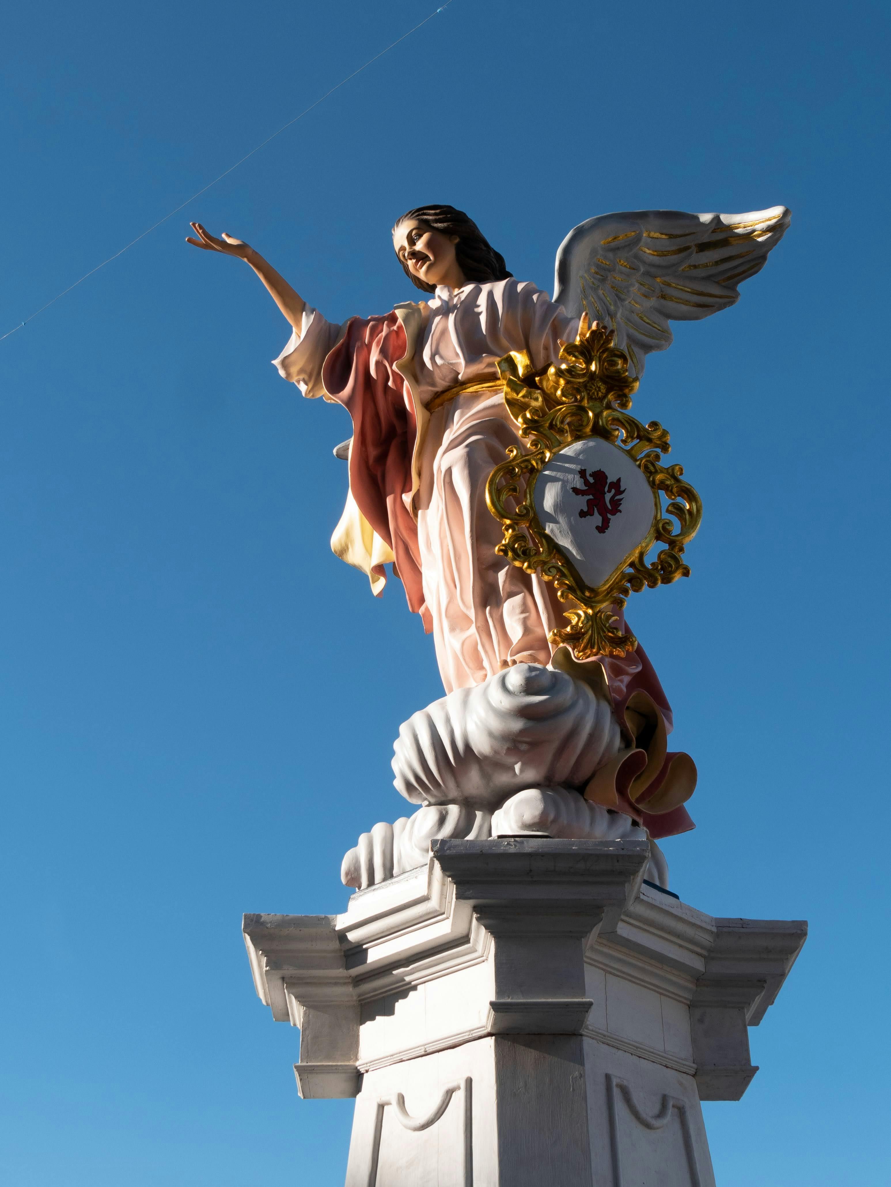 Close-up of a Religious Sculpture on a Pillar against a Clear, Blue Sky ...