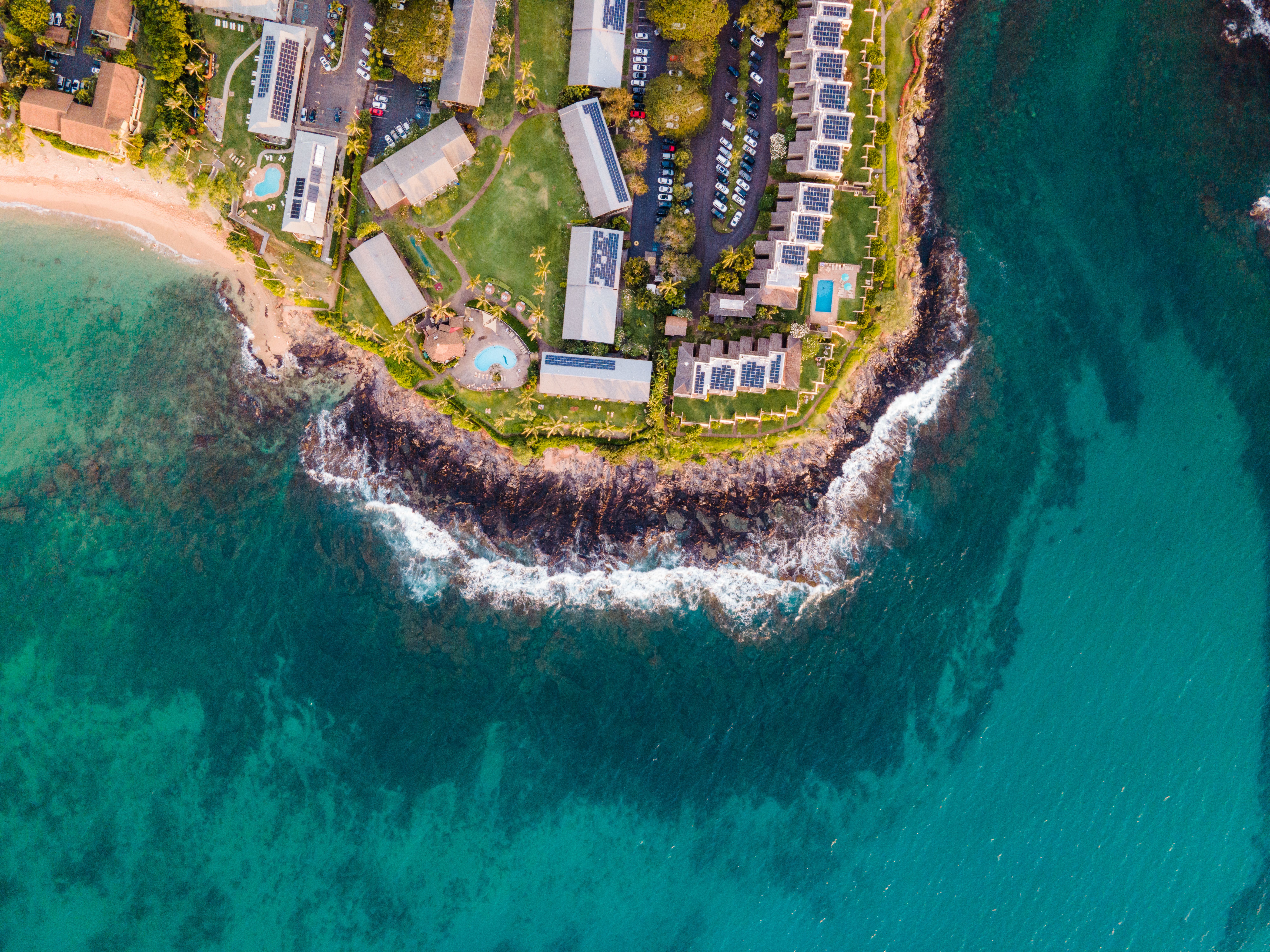 Birds Eye View of Buildings and Rocks on Sea Shore · Free Stock Photo
