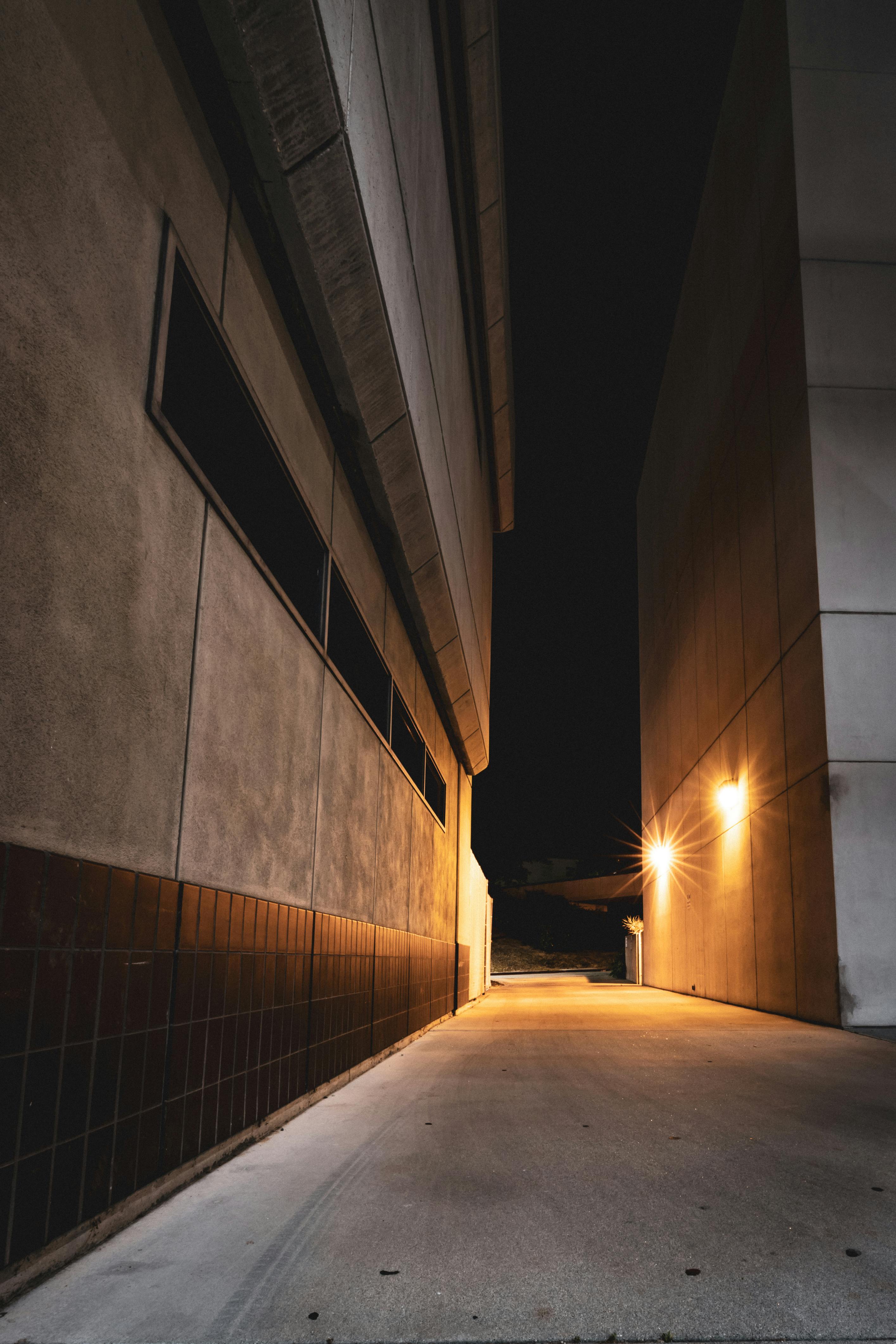 Dark Alley with Concrete Buildings · Free Stock Photo