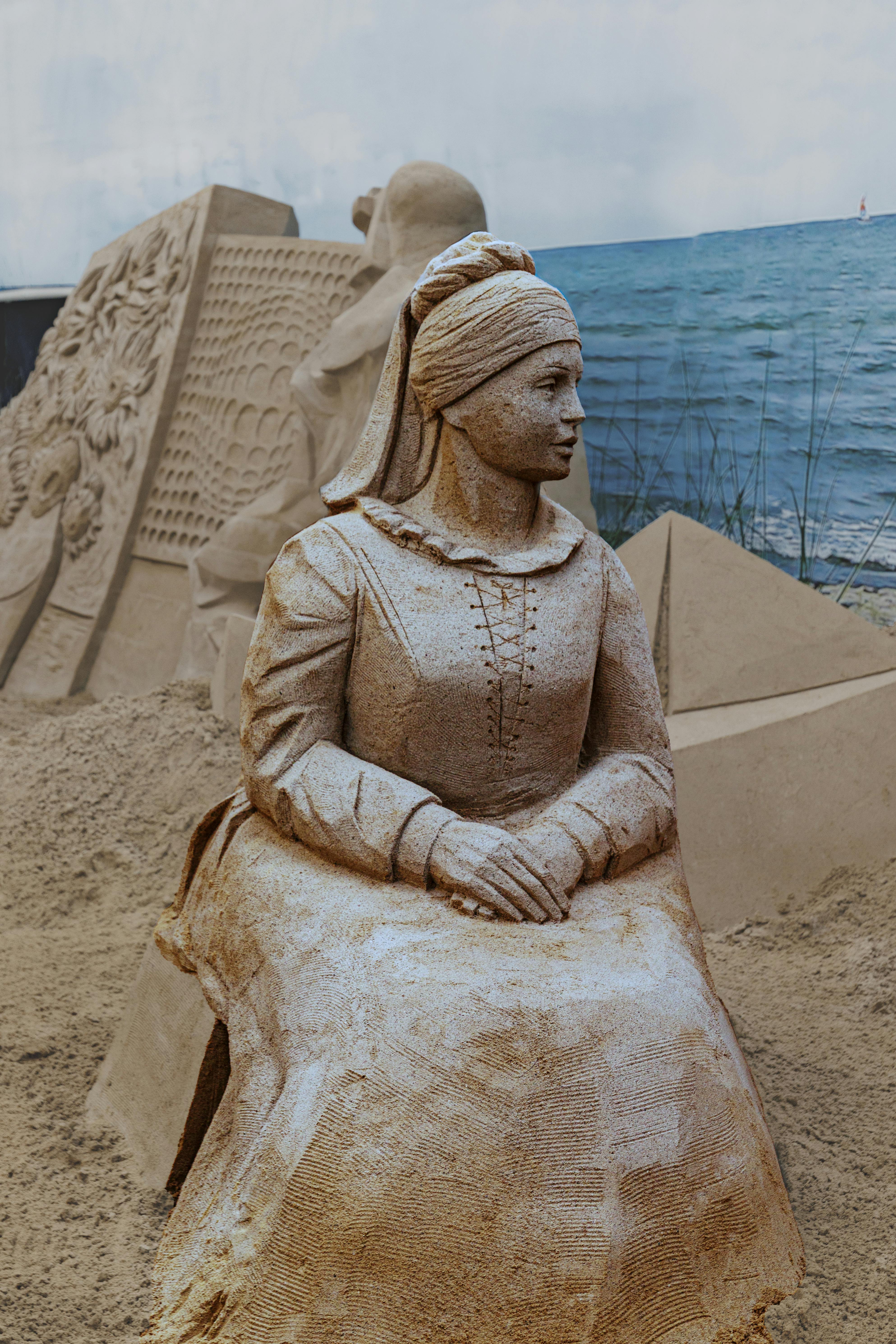 View of a Detailed Sand Sculpture of a Woman on a Beach · Free Stock Photo