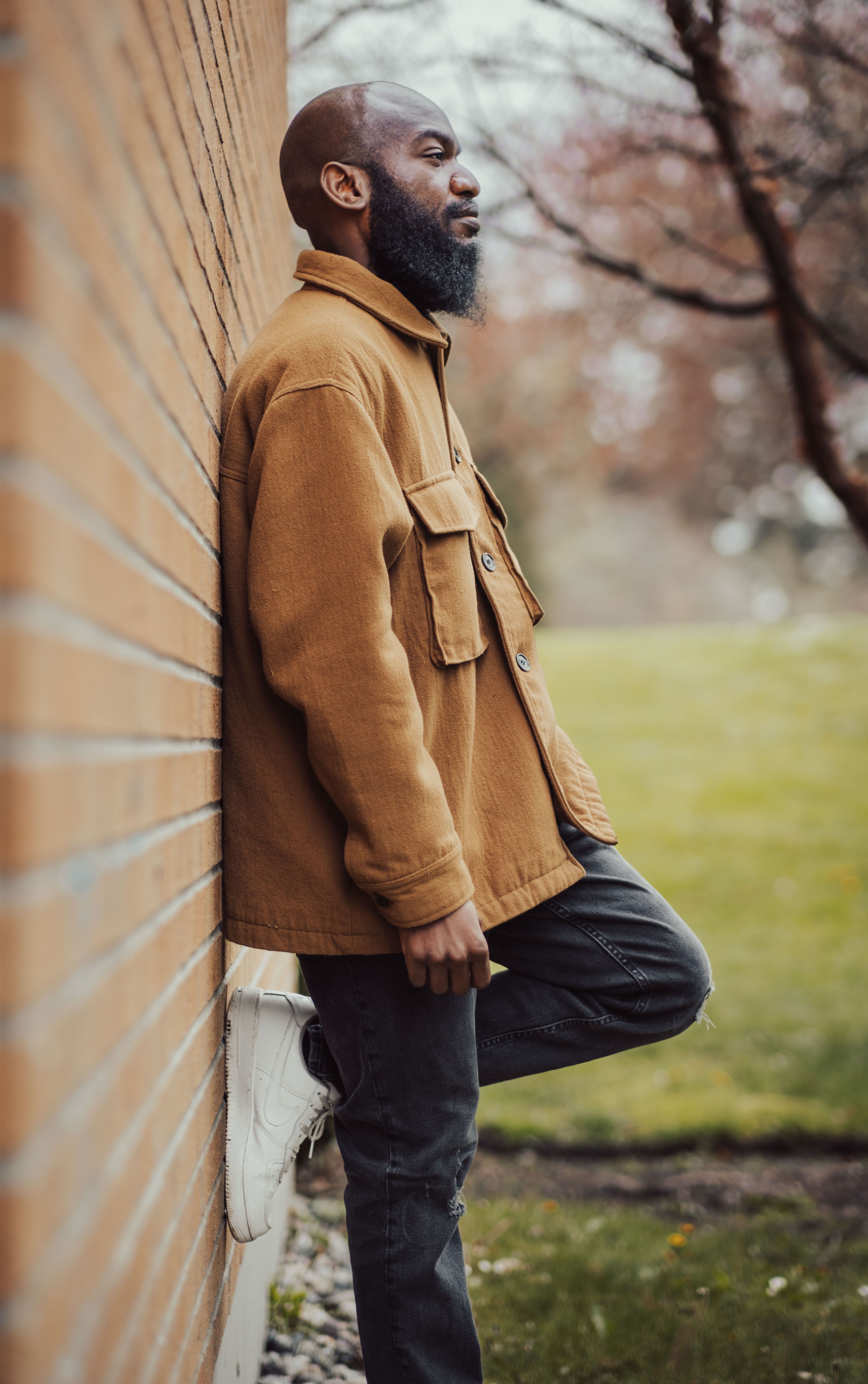 Man with Beard Standing by Wall · Free Stock Photo