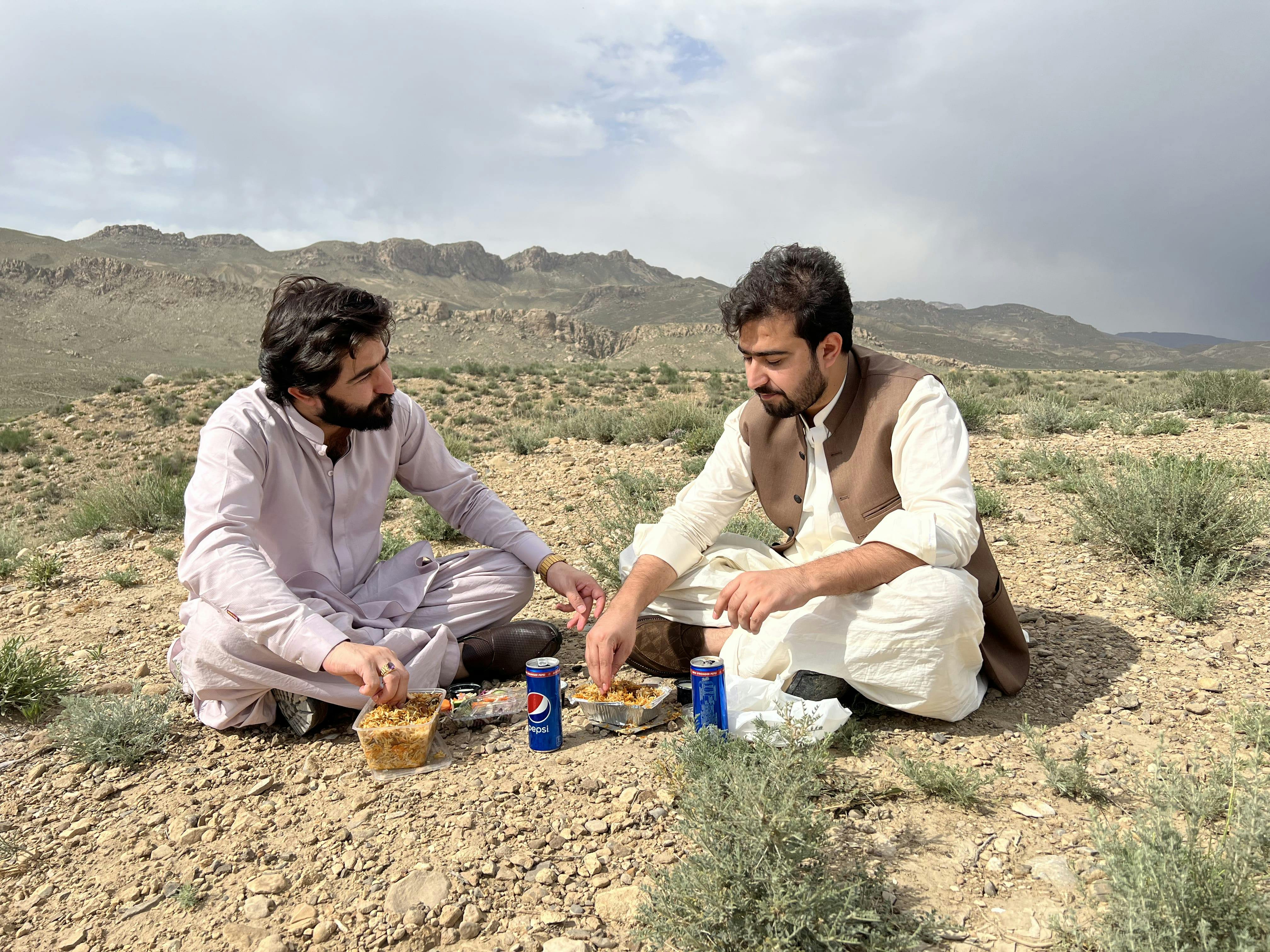 Men Camping with Food and Beverage on Arid Plains · Free Stock Photo