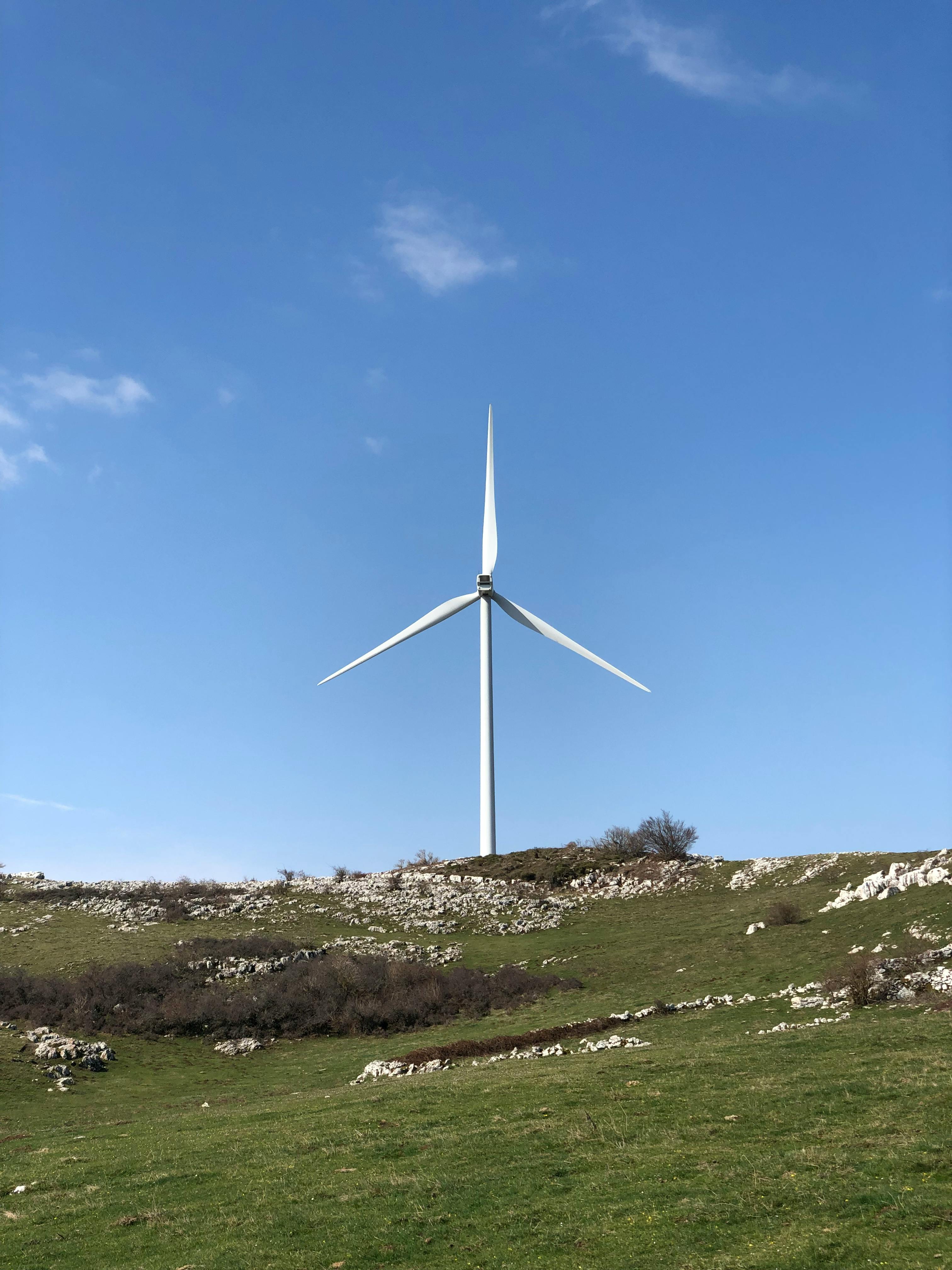 A Wind Turbine of a Field under Blue Sky · Free Stock Photo