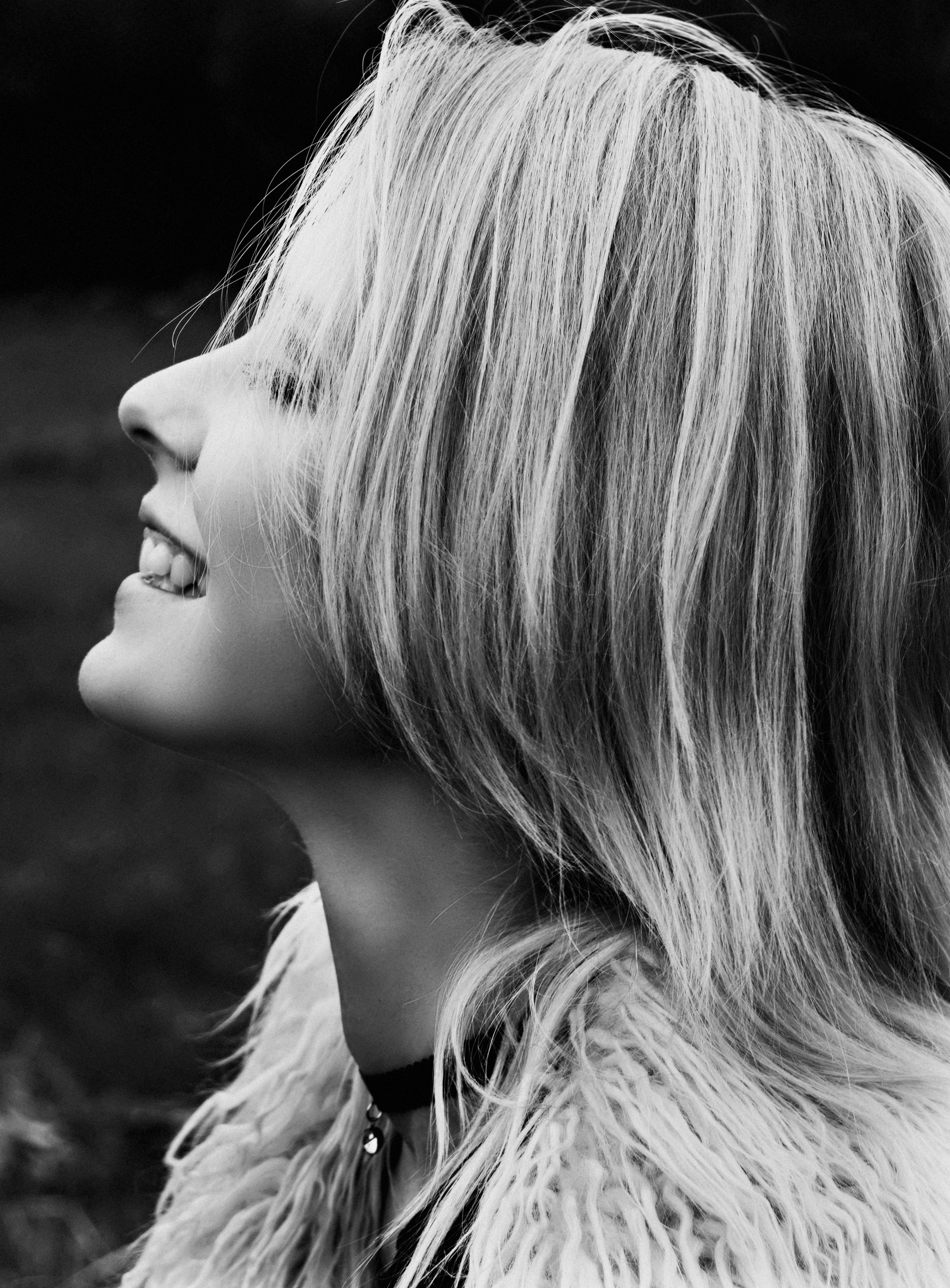 Side View of a Young Woman Smiling · Free Stock Photo