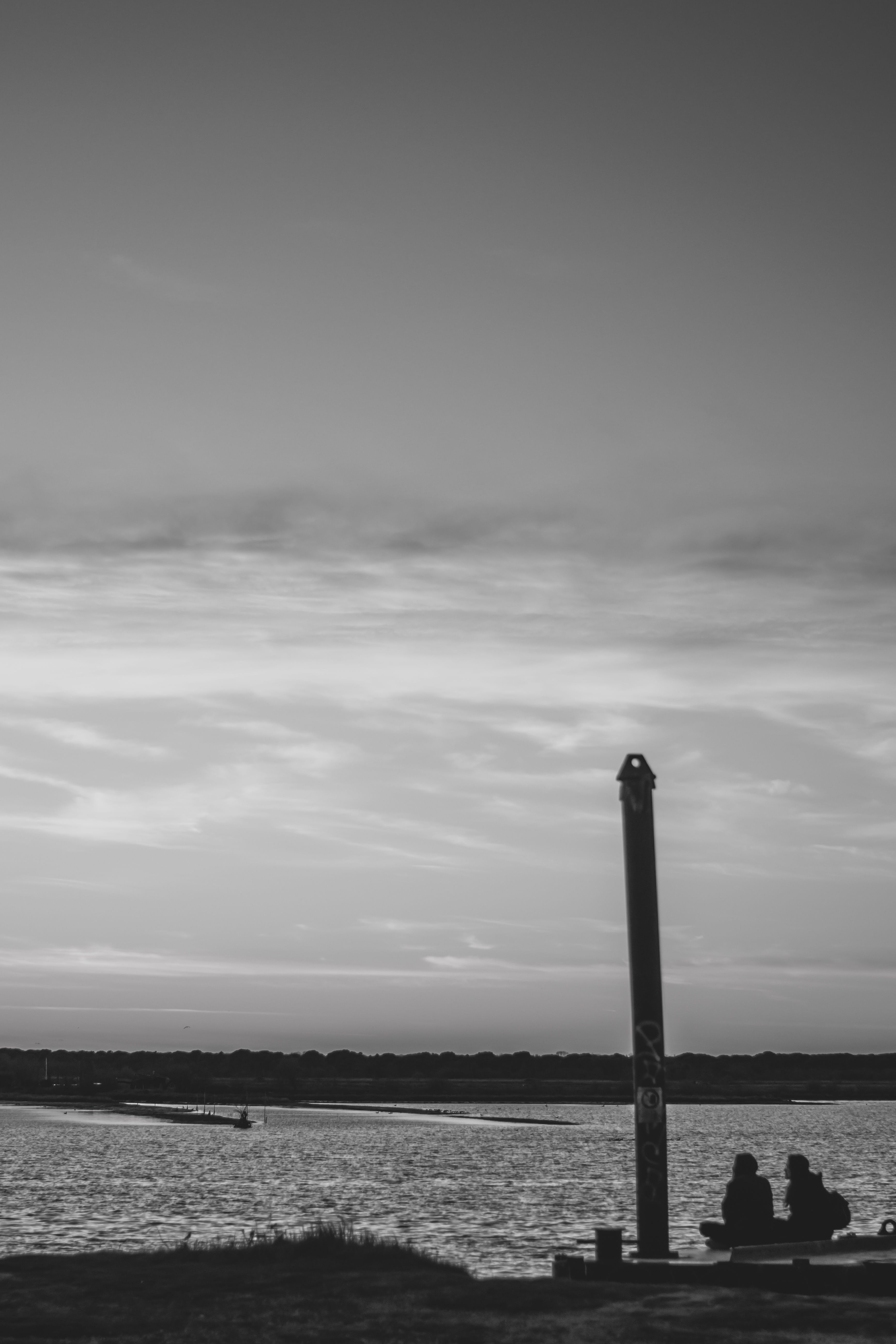 Pavement on River with Bridge behind · Free Stock Photo